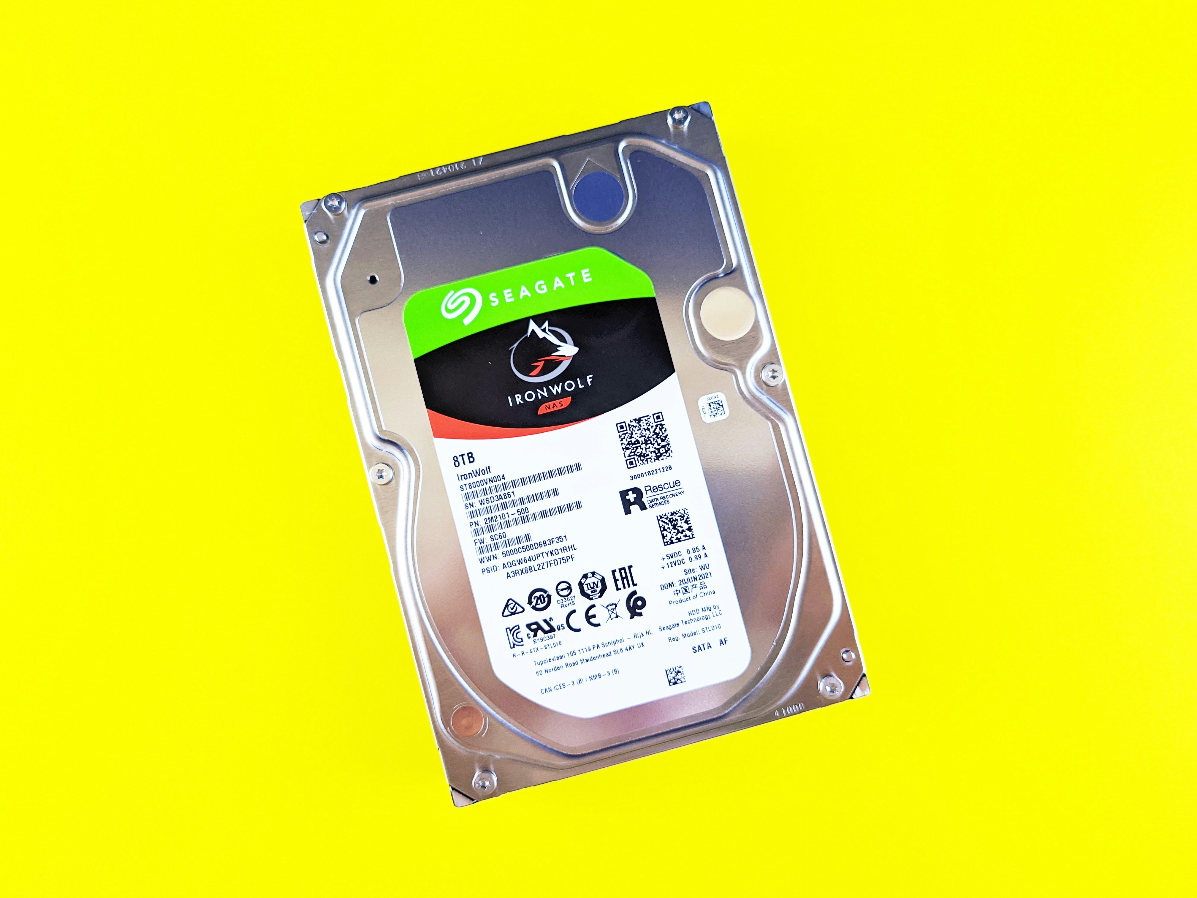 A hard drive sitting on top of a yellow surface photo – Free Hardware ...