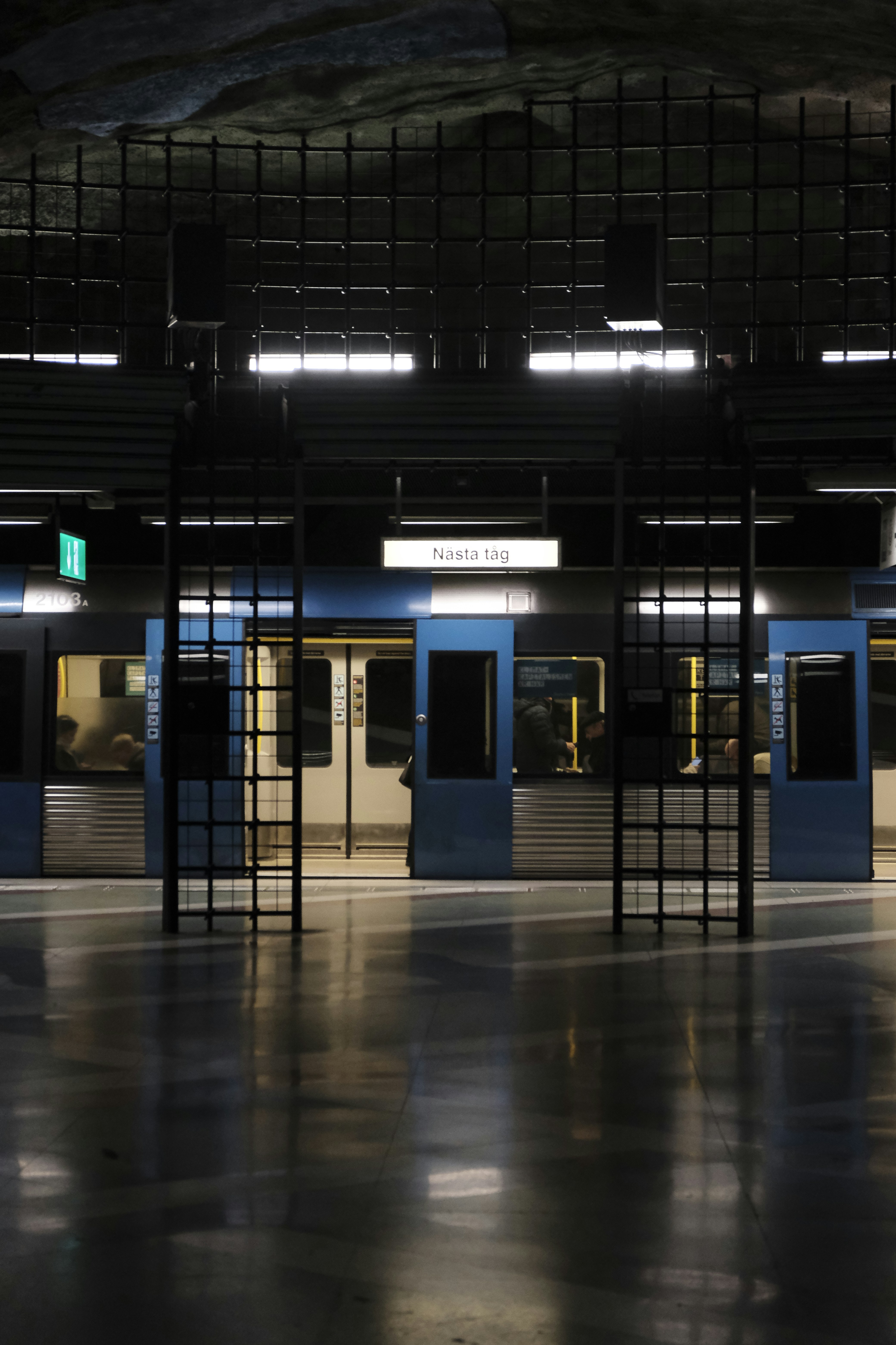 Blue Doors Behind Iron Grids: Midnight Silence at the Station
