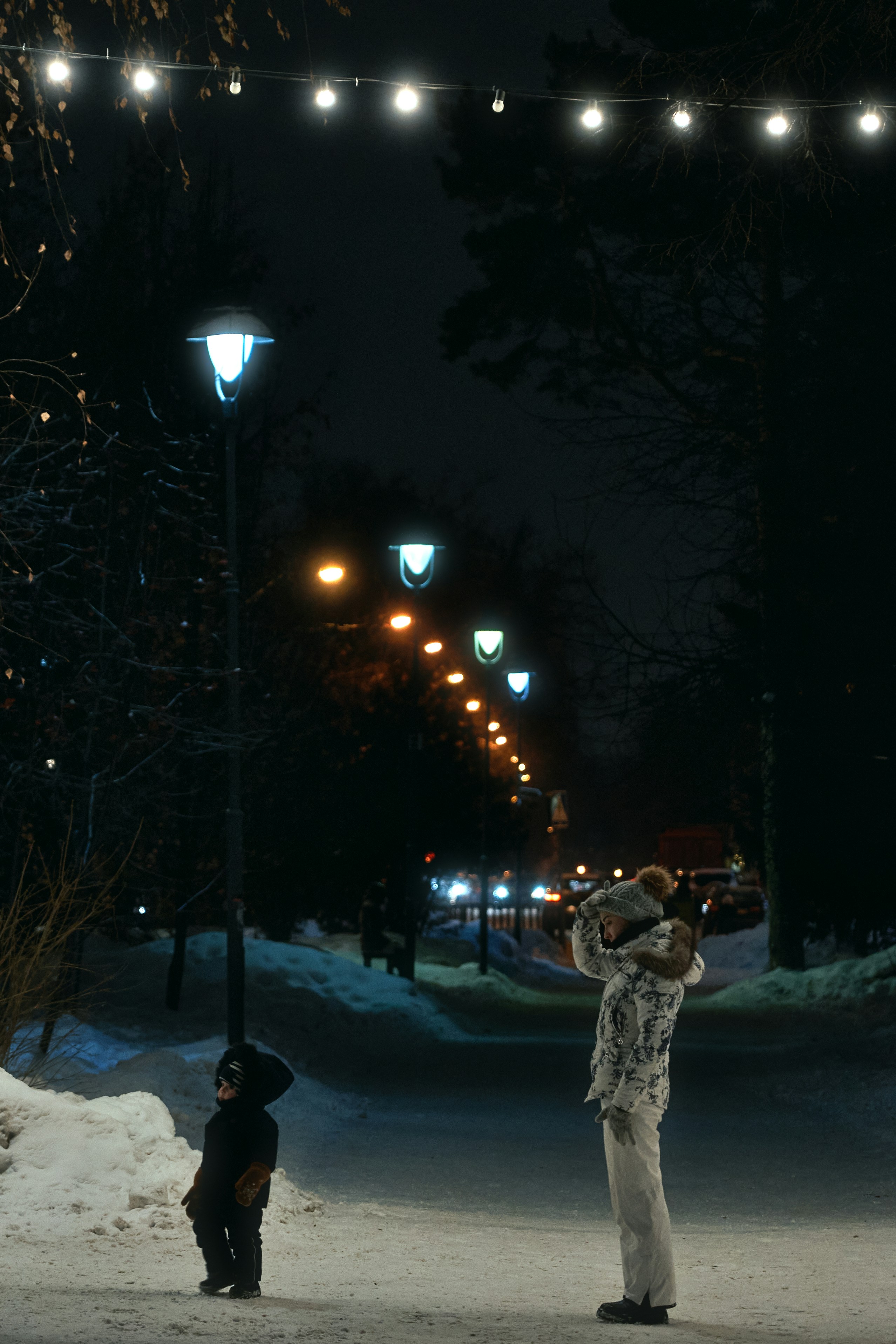 Lantern-lit Snow: A Quiet Night Portrait on the Park Path