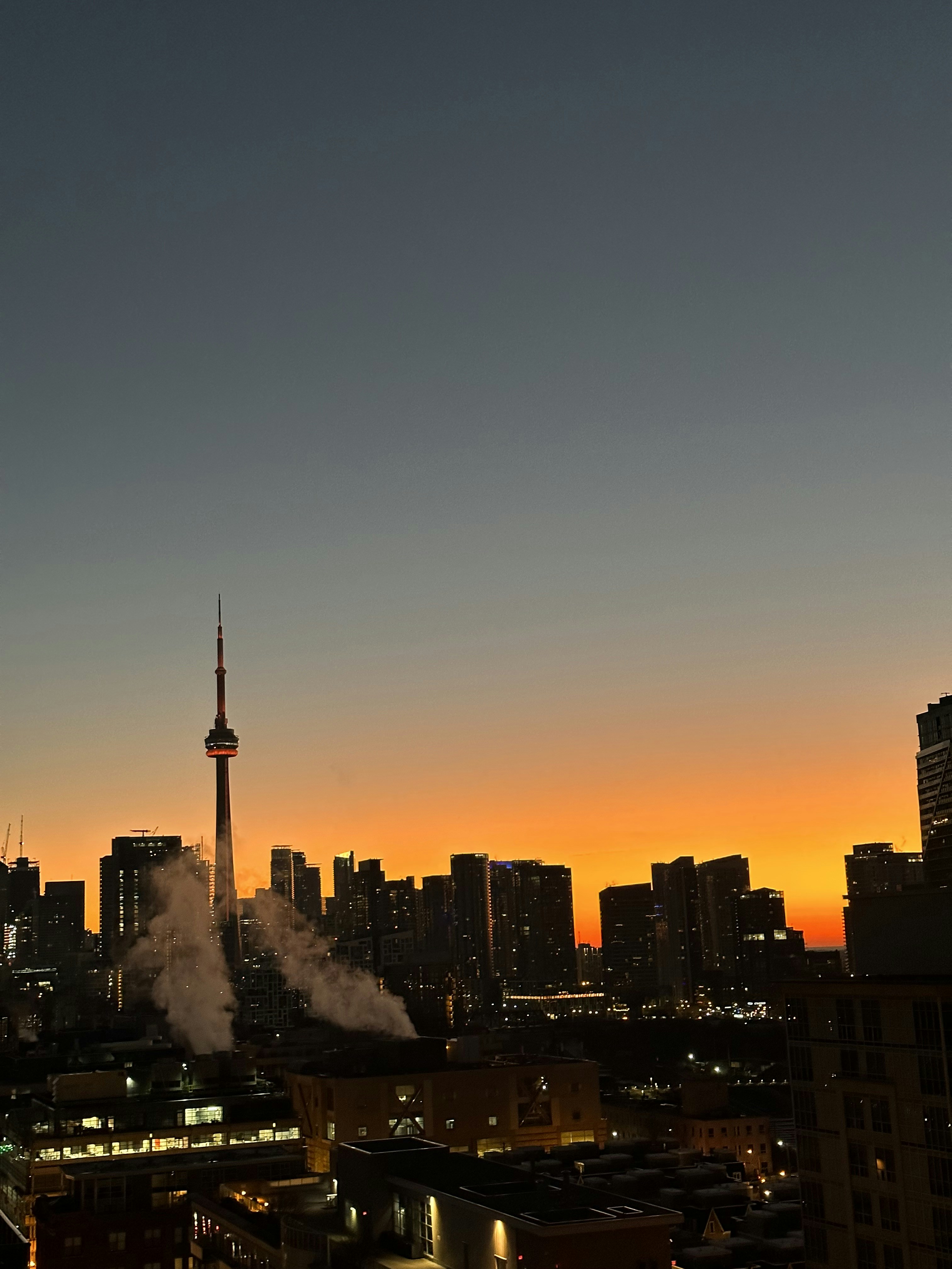 City Skyline at Twilight: The CN Tower Pierces a Golden Horizon