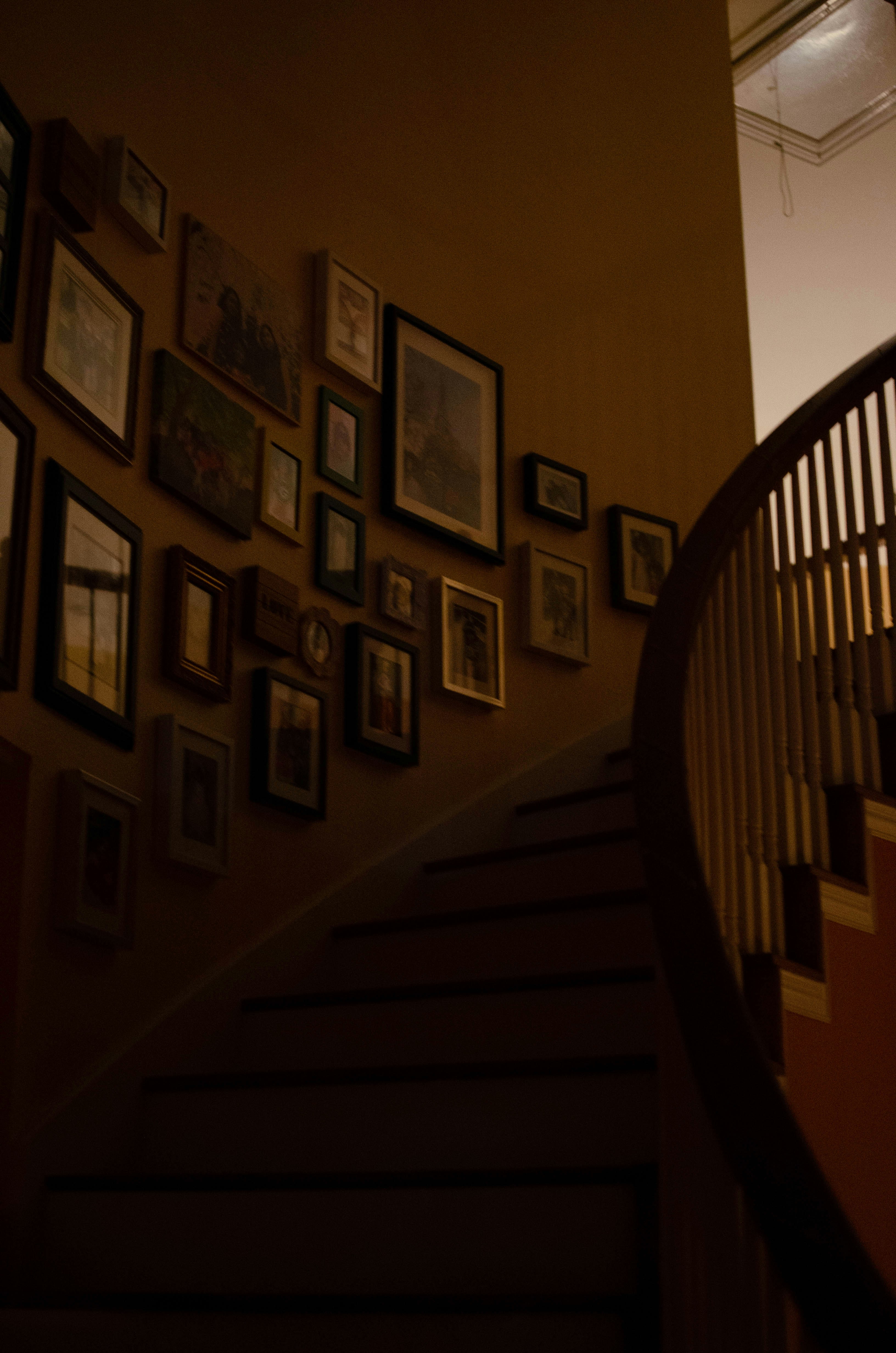 Whispers on the Wall: A Gallery of Framed Moments Along a Quiet Staircase