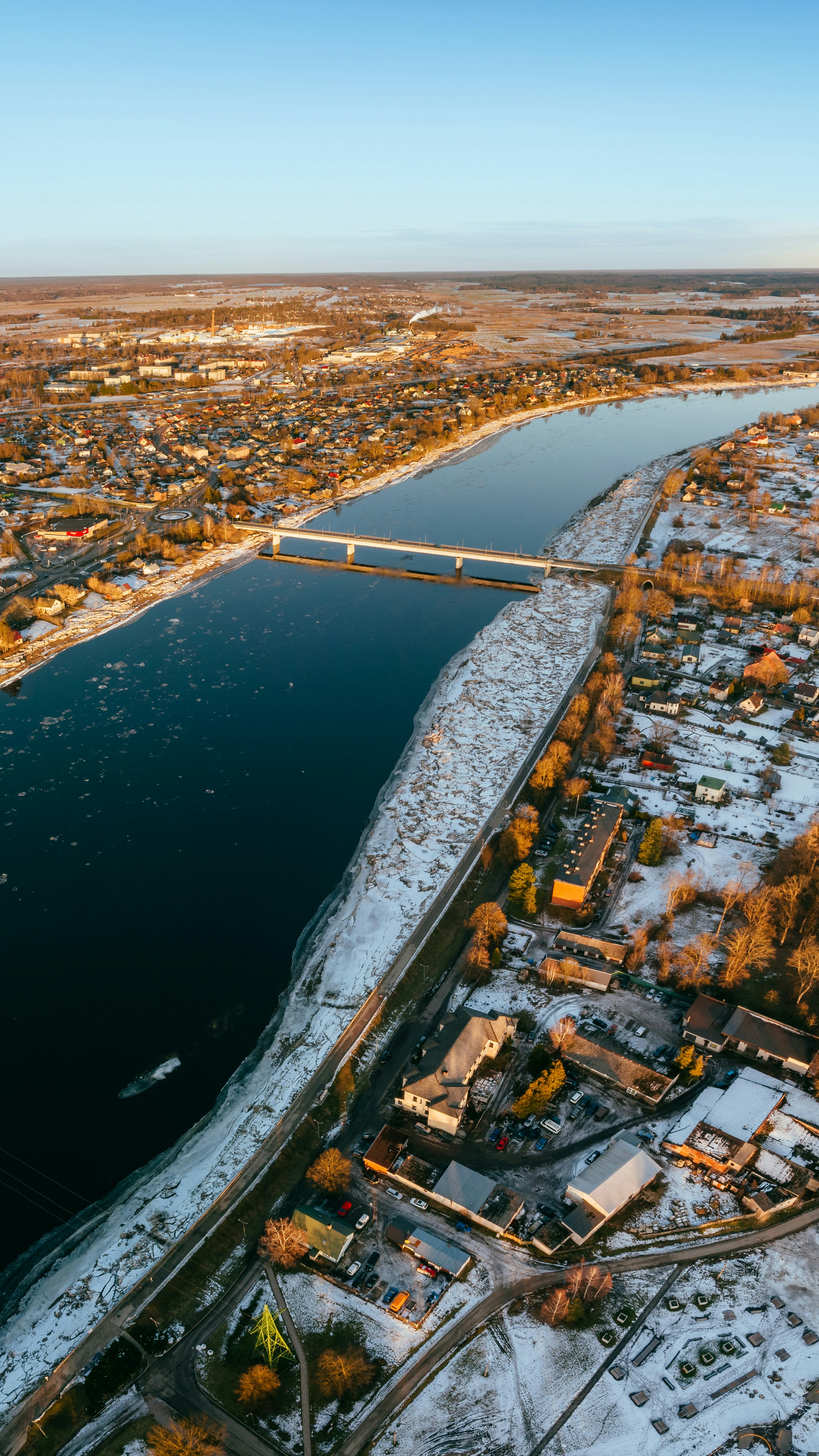 Frozen Bend: Aerial Winter Corridor Across a Snow-Veiled River