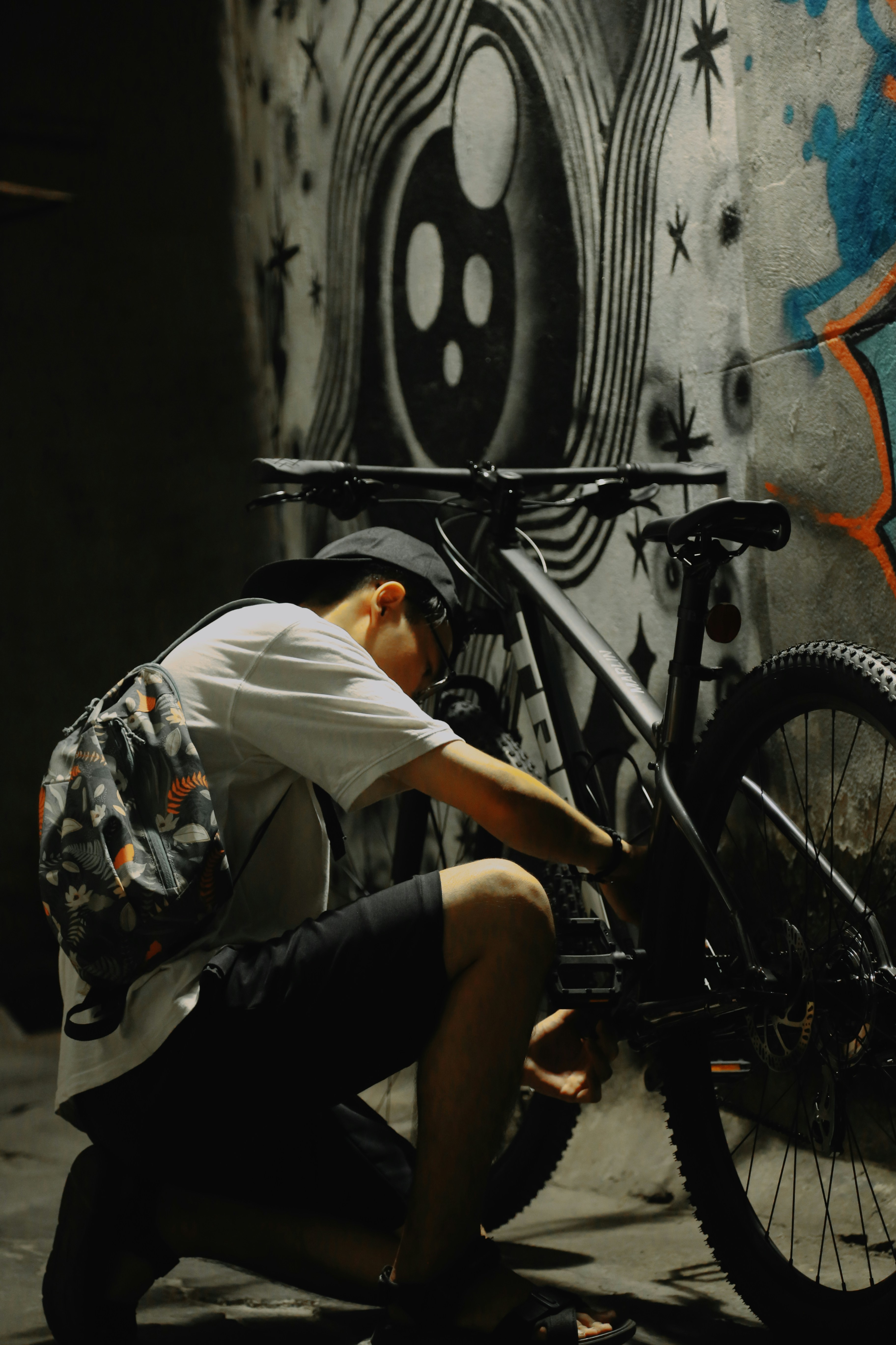 Gear and Graffiti: A Bike Repair in an Urban Underpass