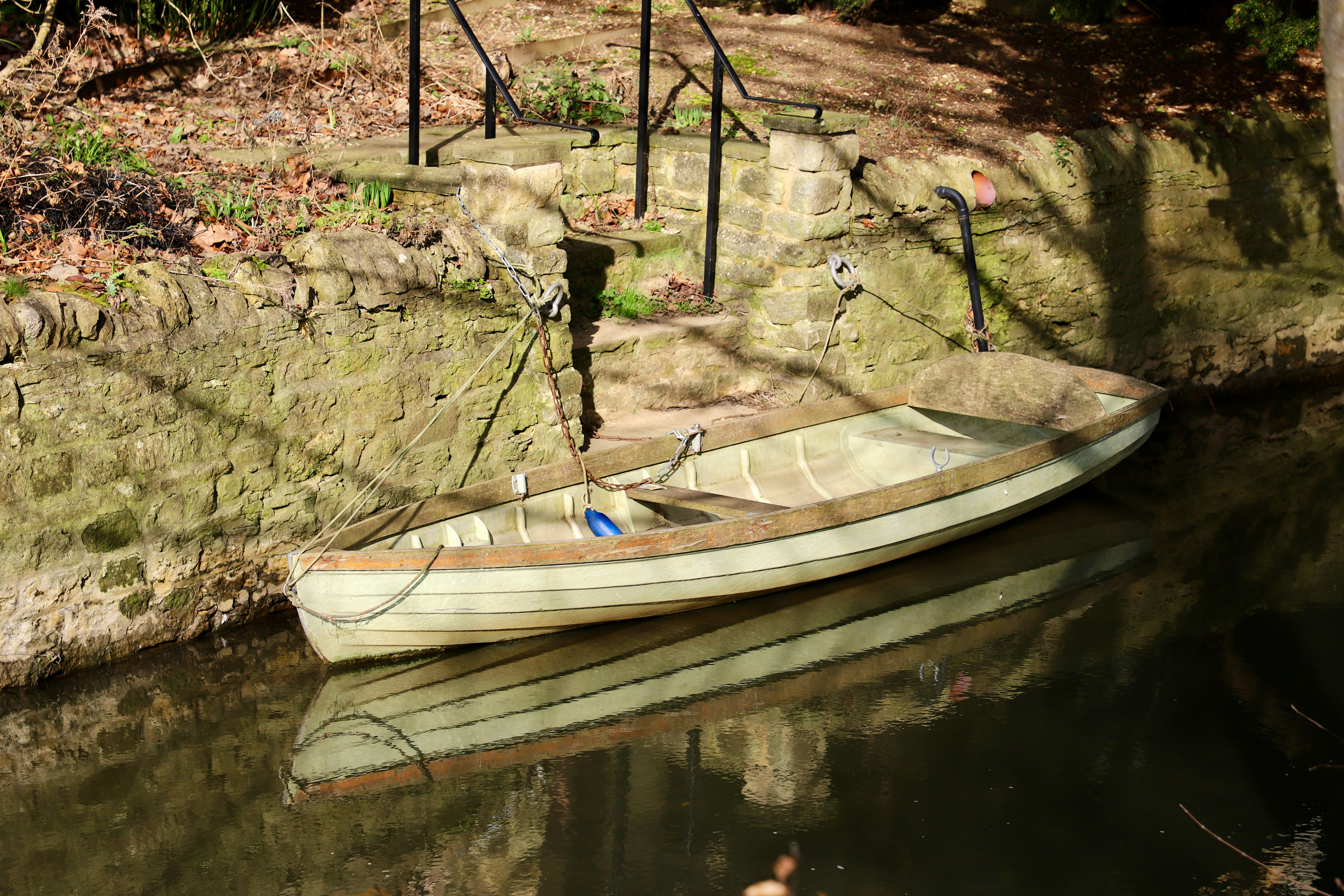 a small boat sitting on top of a body of water
