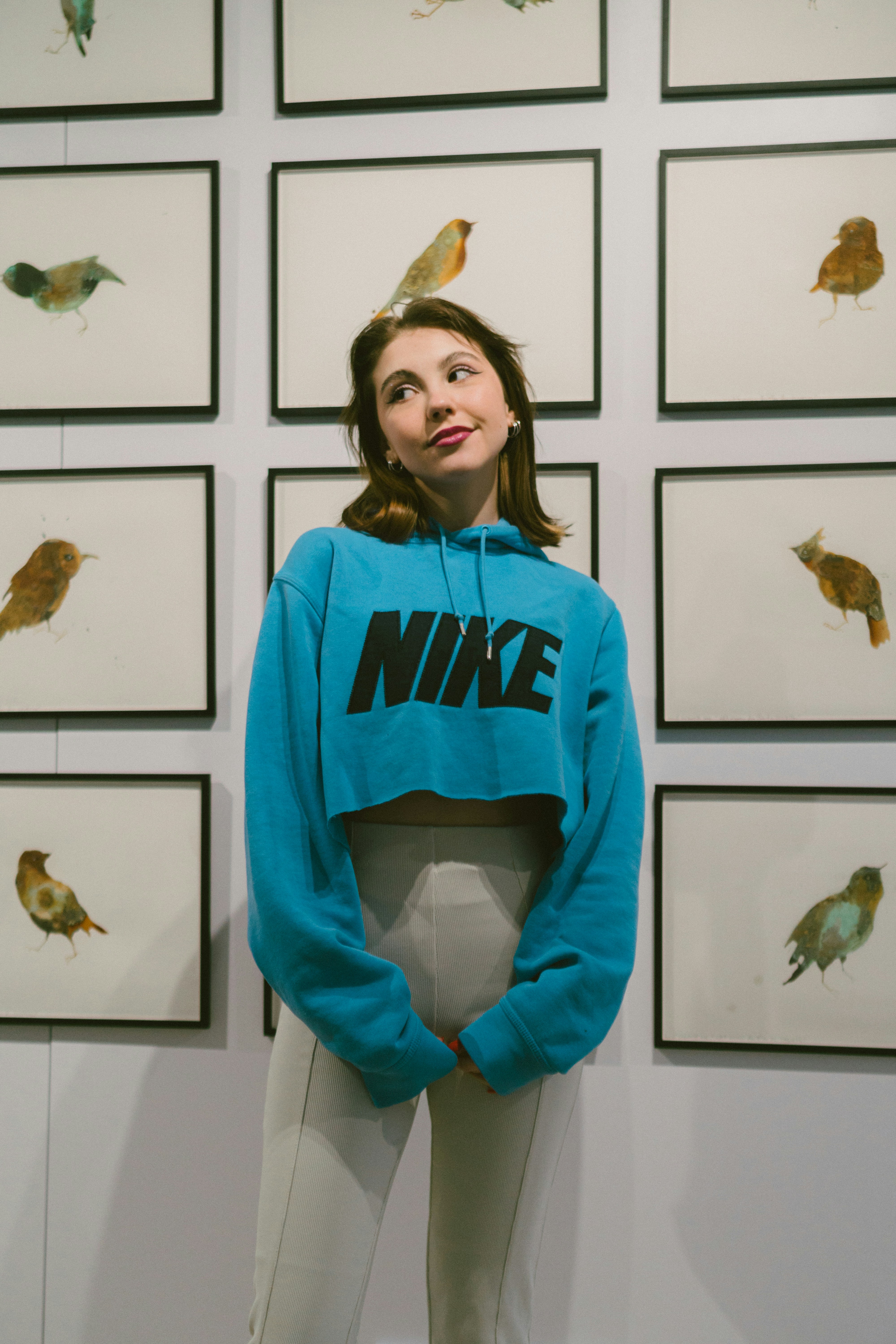 Electric Blue Hoodie Amid a Grid of Bird Portraits