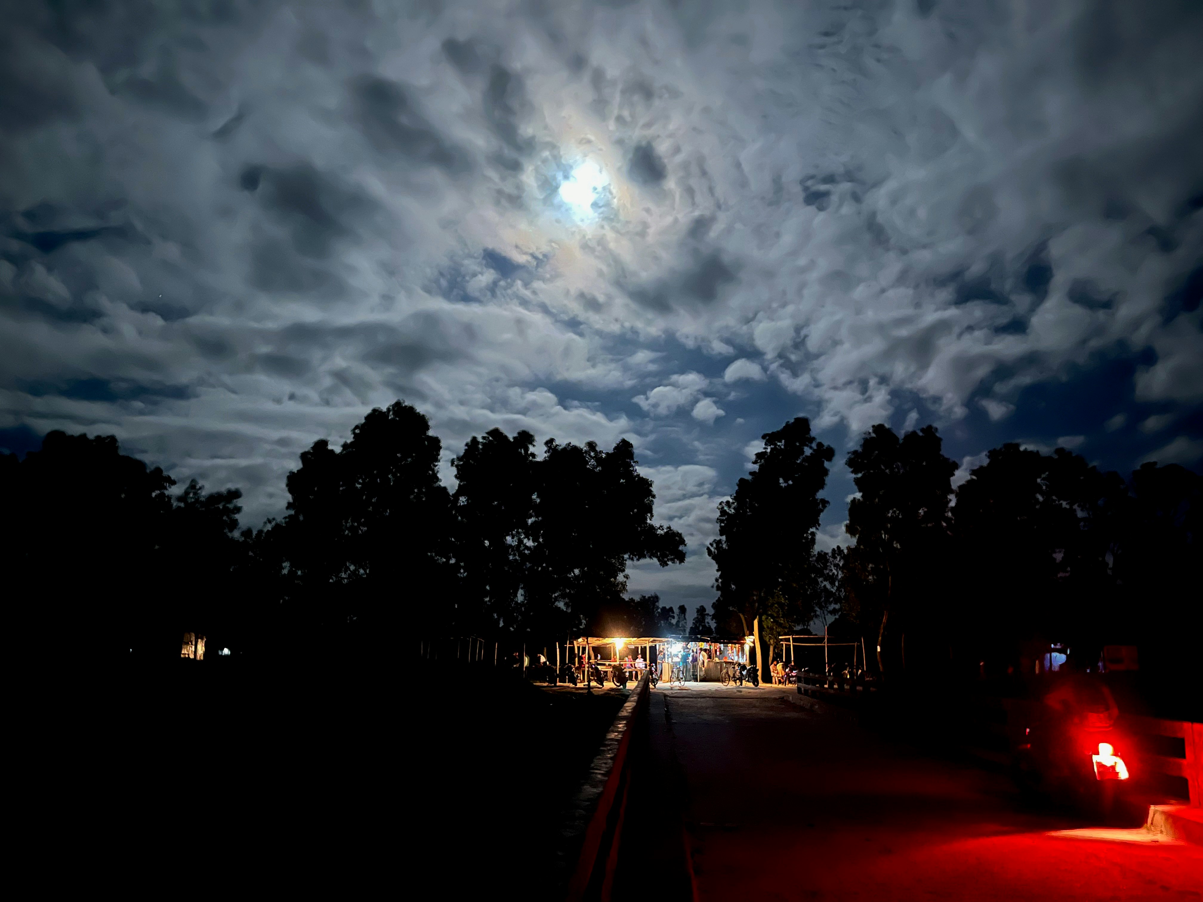 A full moon shines brightly in the sky above a street photo – Free City ...
