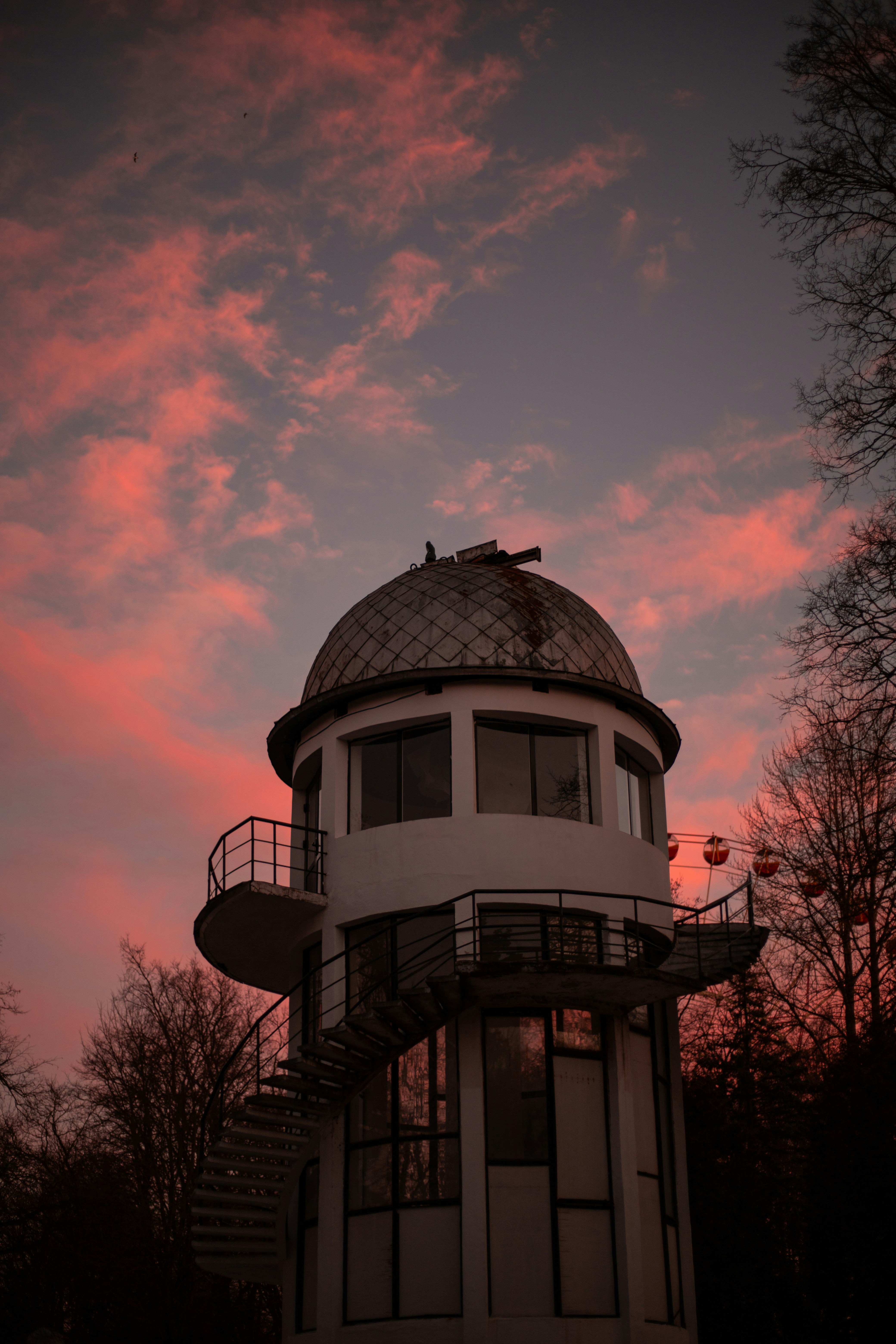Dusk over the Dome: A Watchtower of Glass and Metal Beneath Coral Skies
