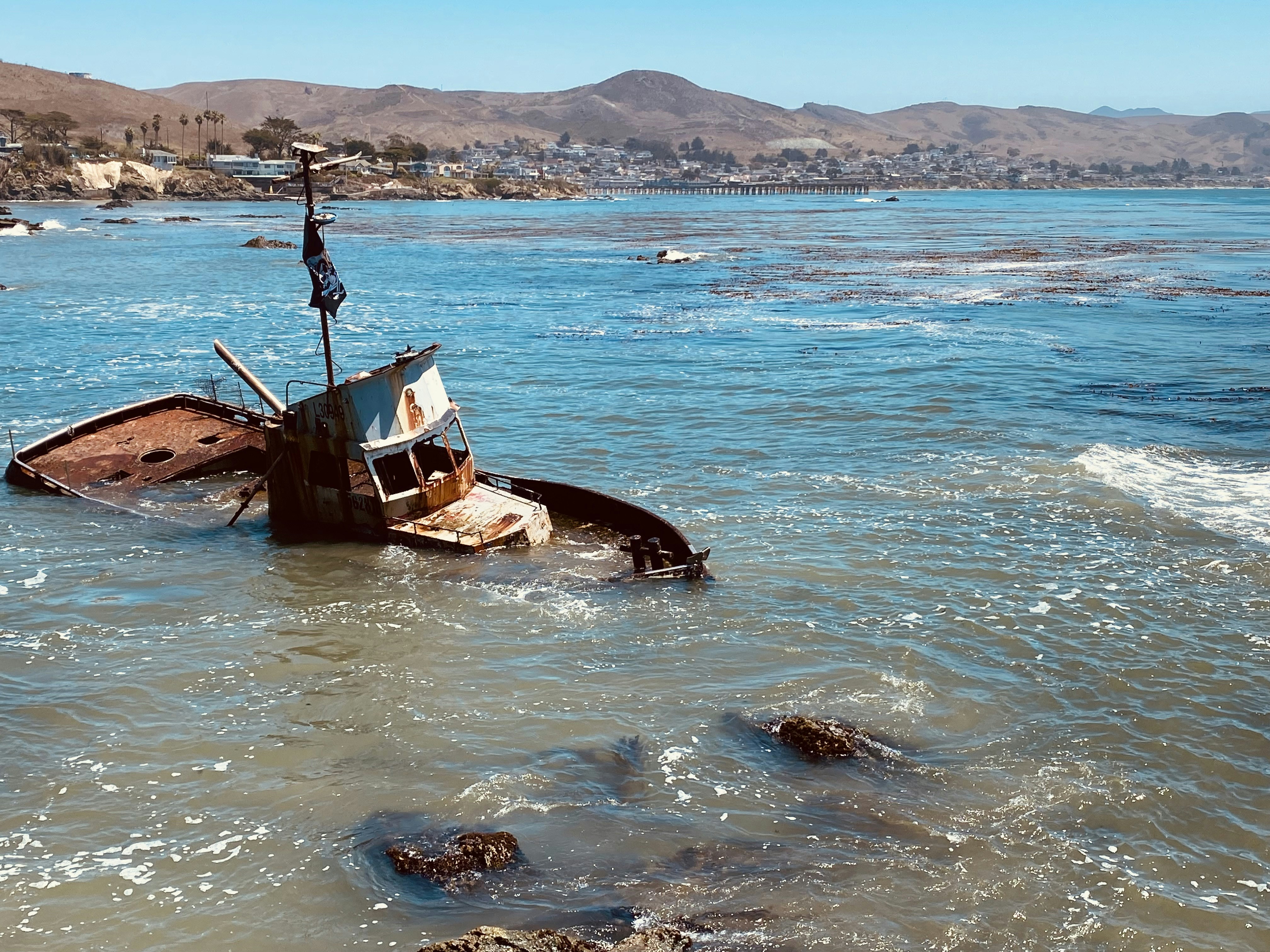 Rust and Ripples: A Wreck Resting in a Turquoise Bay