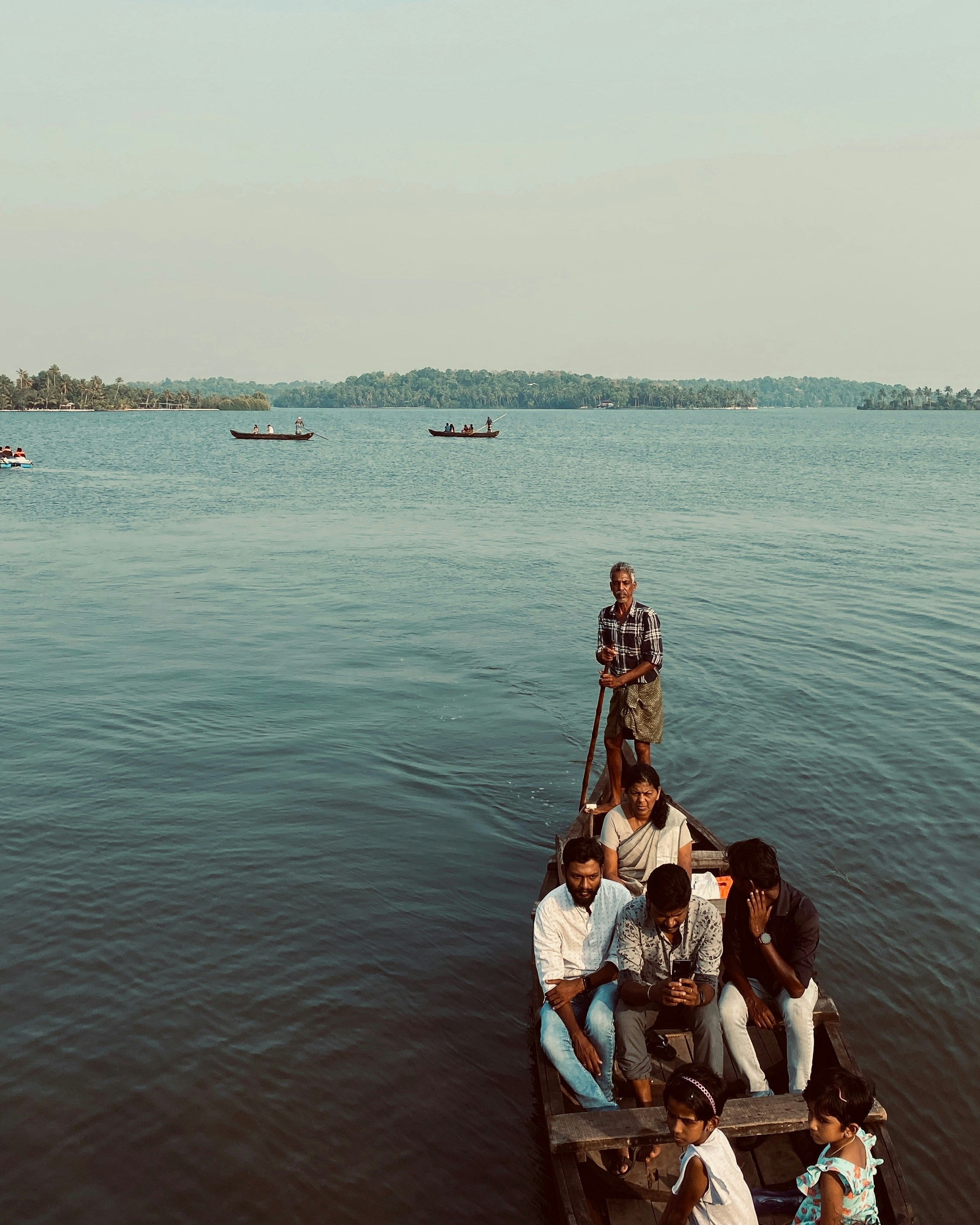 Quiet Refuge: Friends On a Wooden Boat on a Serene Lake