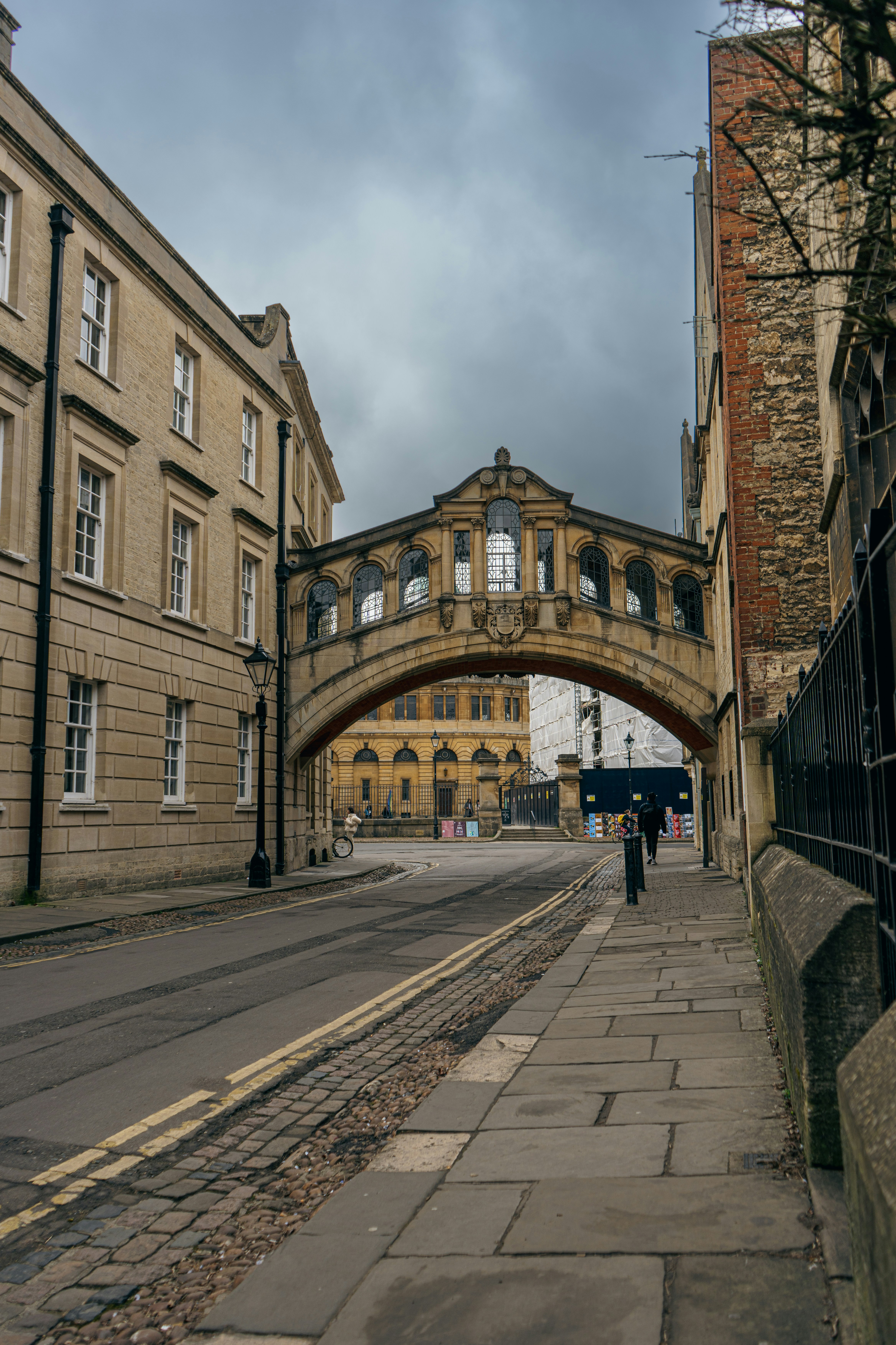 A stone bridge over a street next to tall buildings photo – Free Oxford ...
