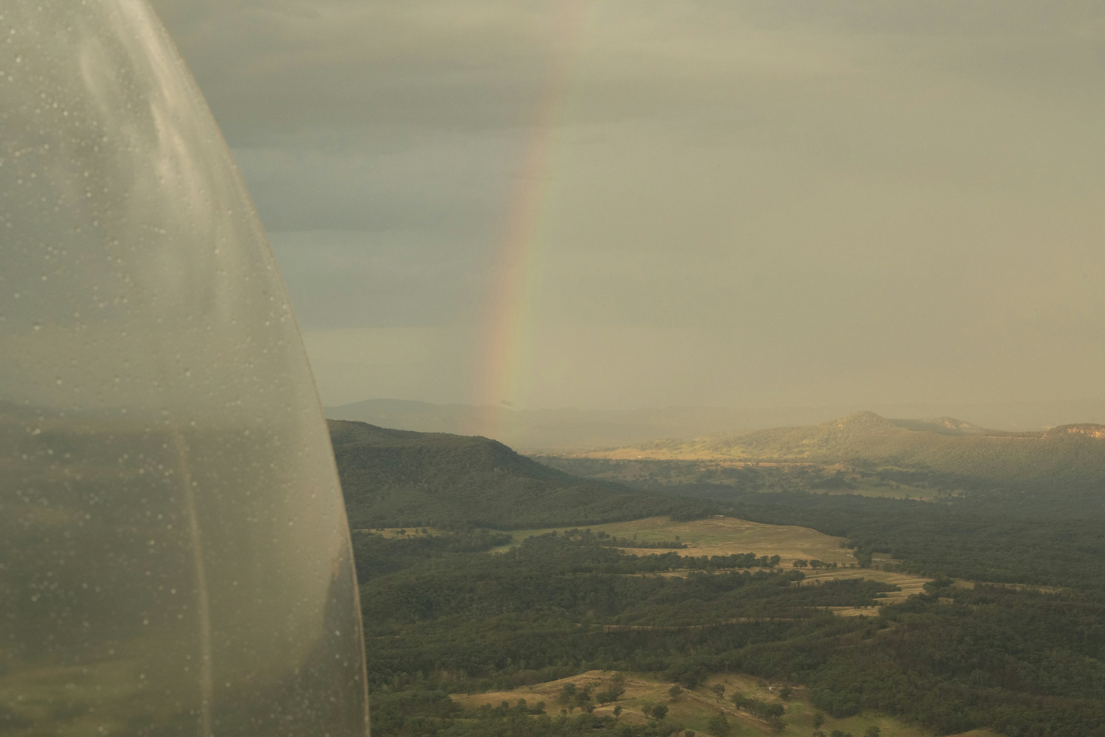 A view of a rainbow from a plane window photo – Free Australia Image on ...
