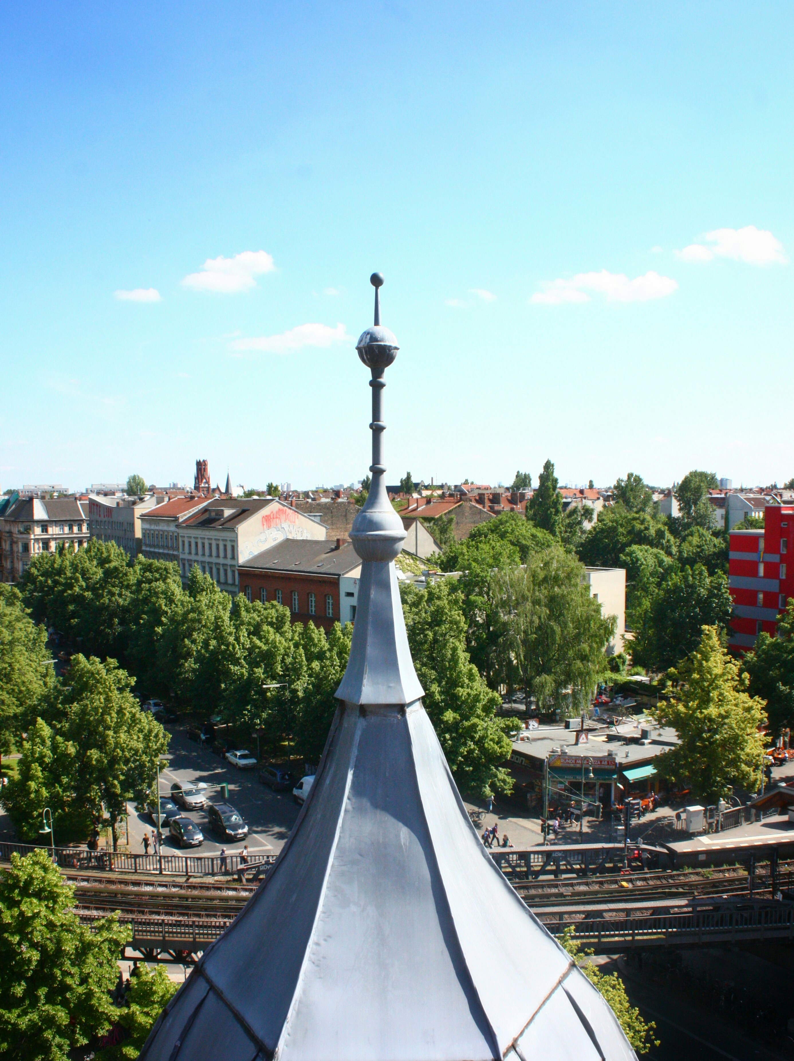 Spire Crown Over a Verdant Cityscape Under a Bright Sky