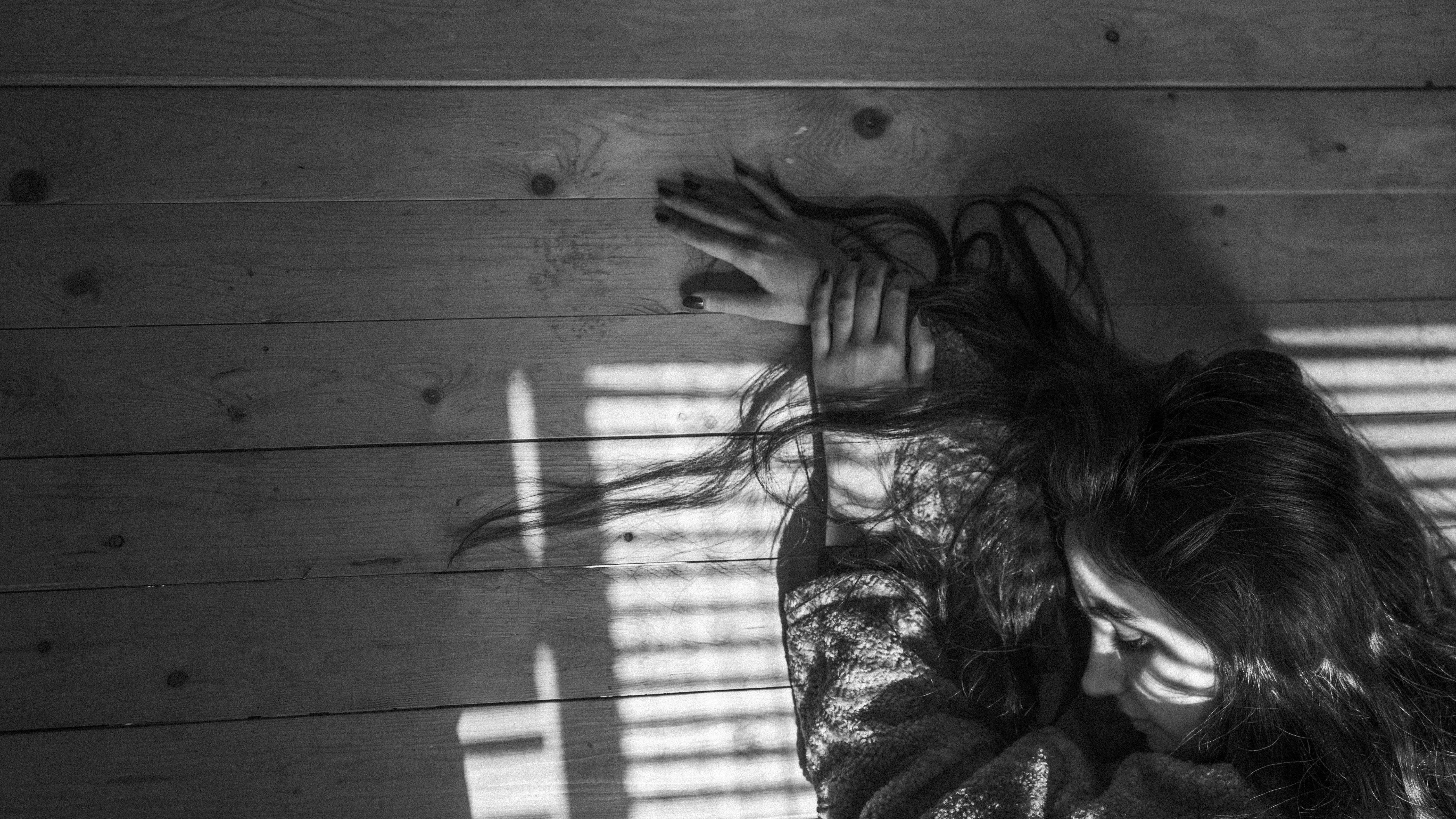 Stripes of Light, Quiet Pose: A Monochrome Floor Portrait