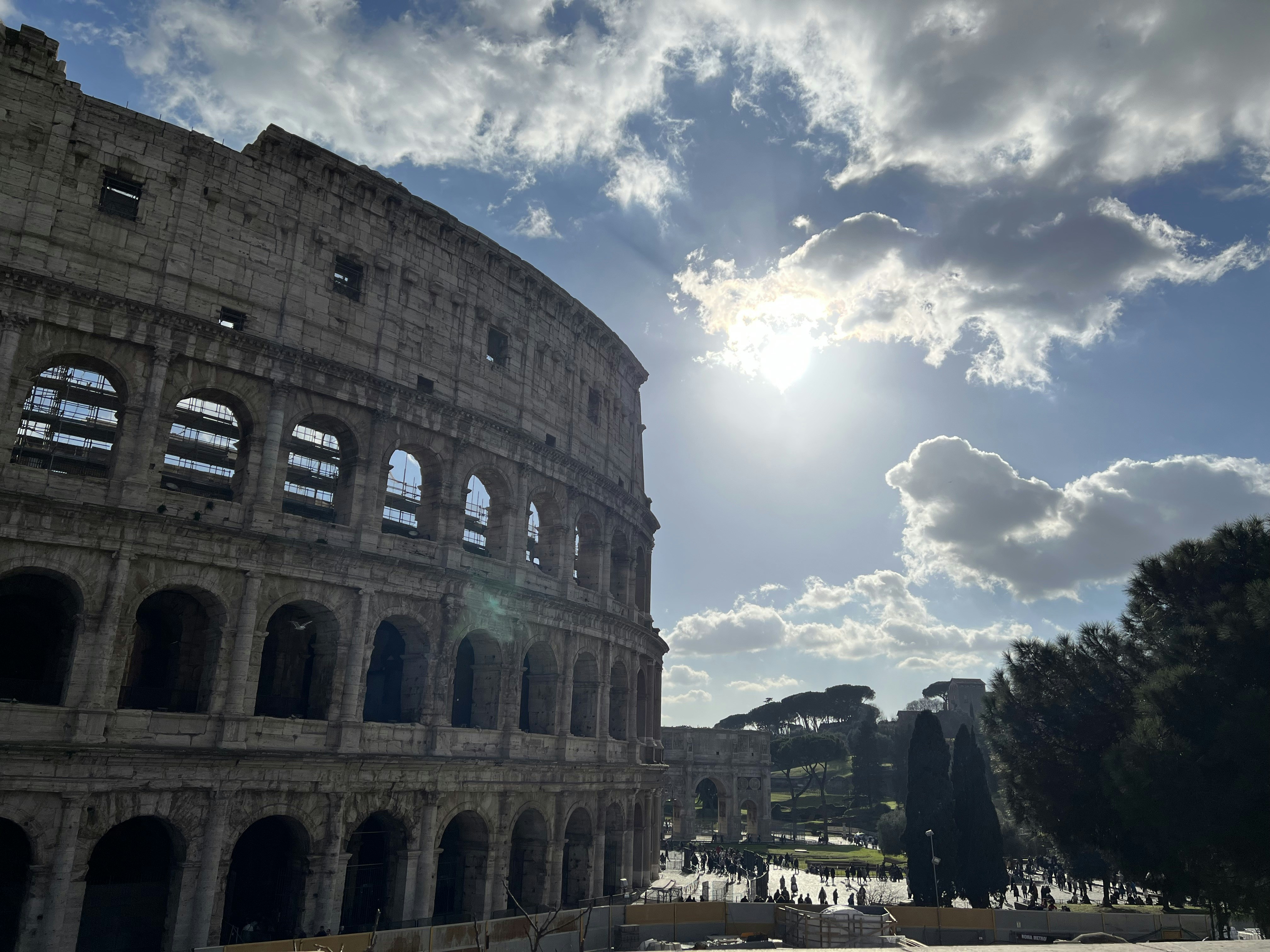 The sun shines through the clouds over the roman colossion photo – Free ...