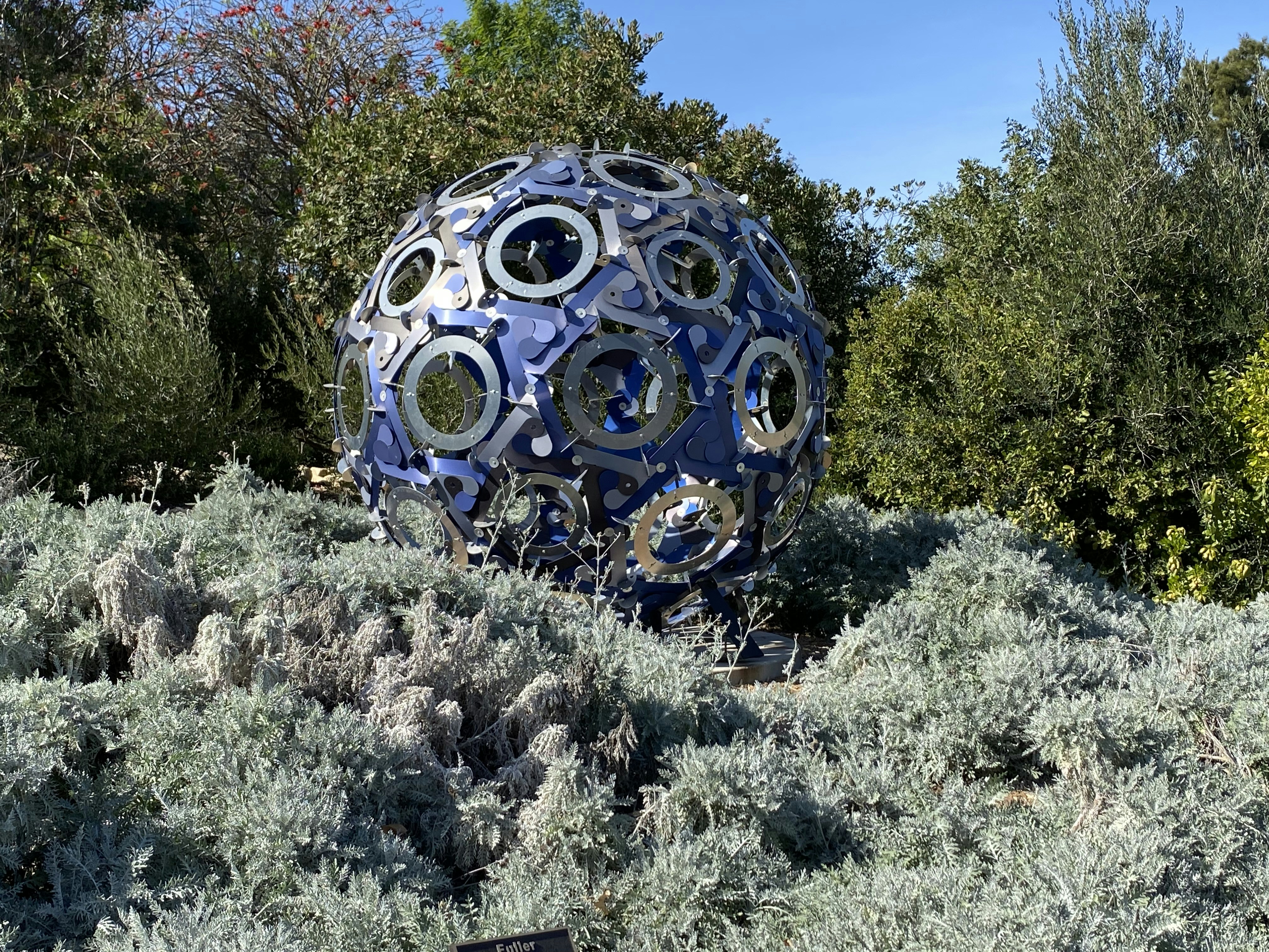 Circular Echo: A Ringed Steel Sphere in the Garden