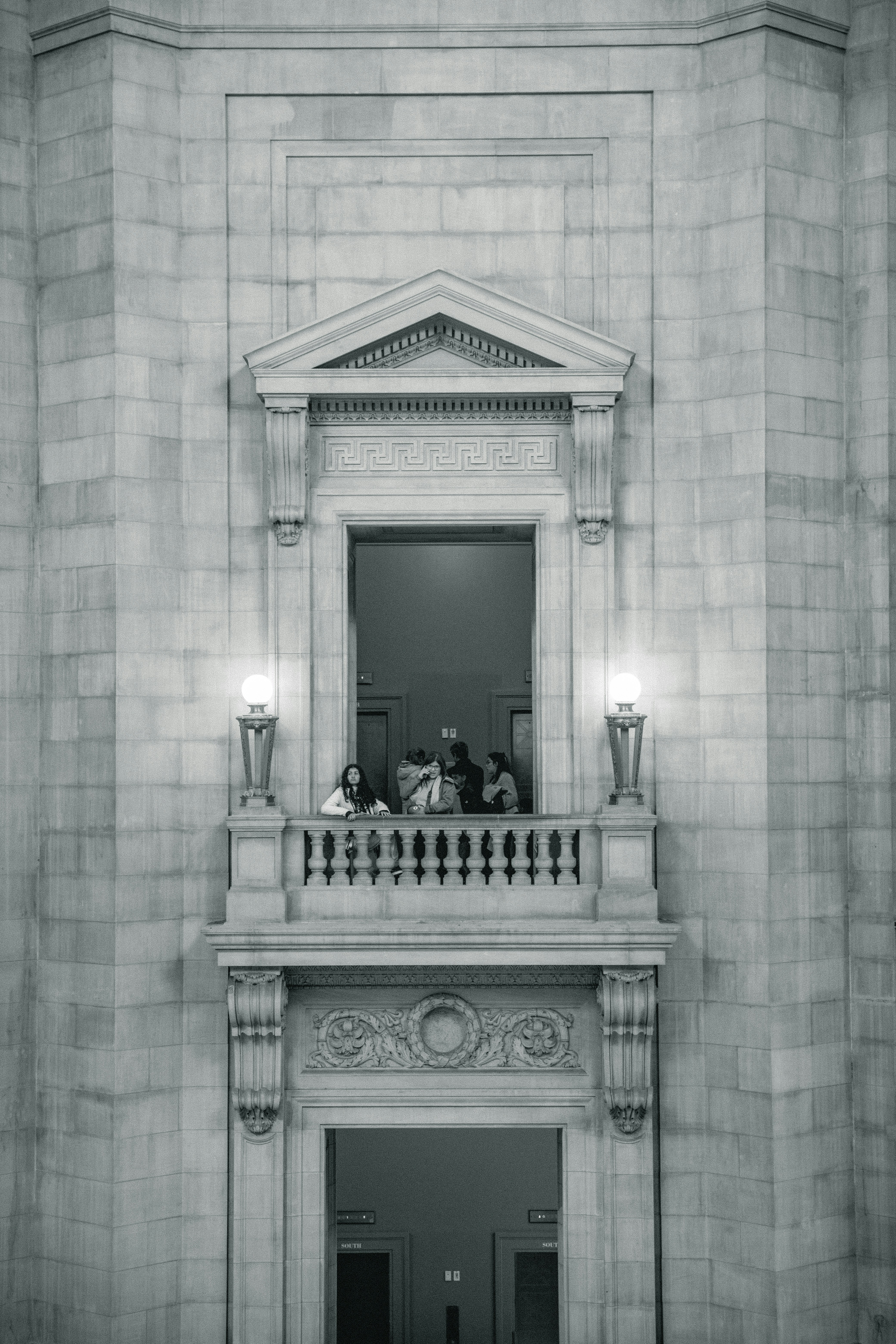 Marble Balcony Symposium: Quiet Faces in a Monumental Atrium