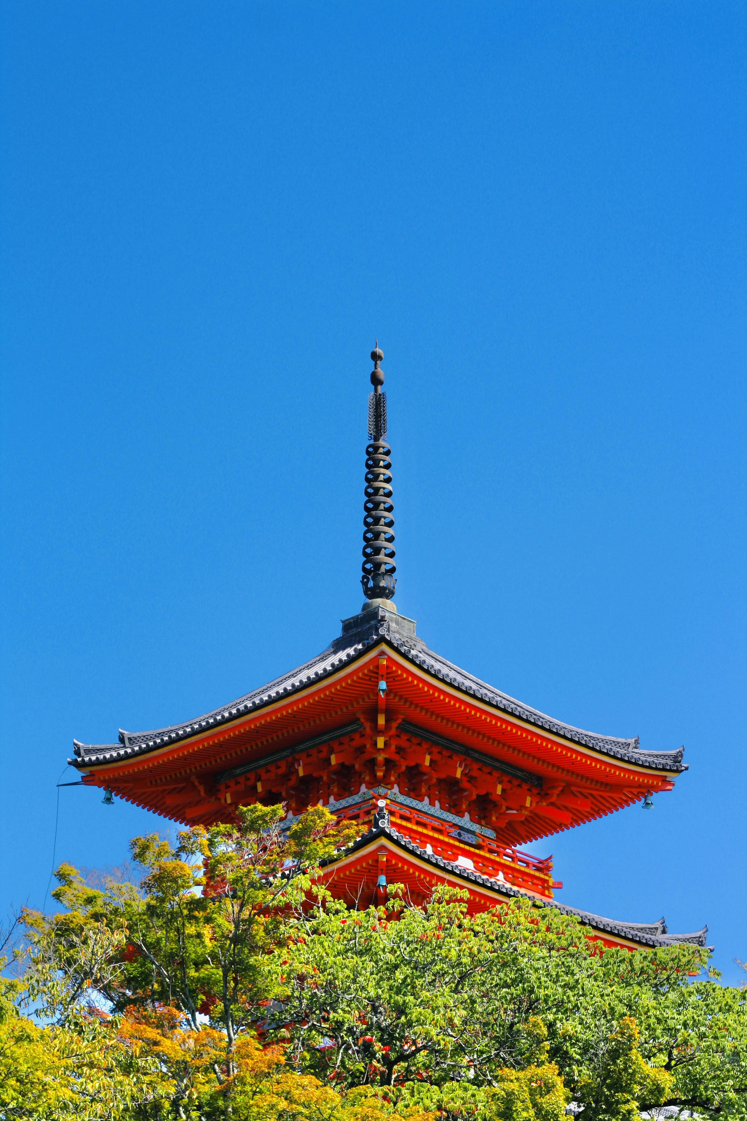 A tall red building with a tall tower on top of it photo – Free ...