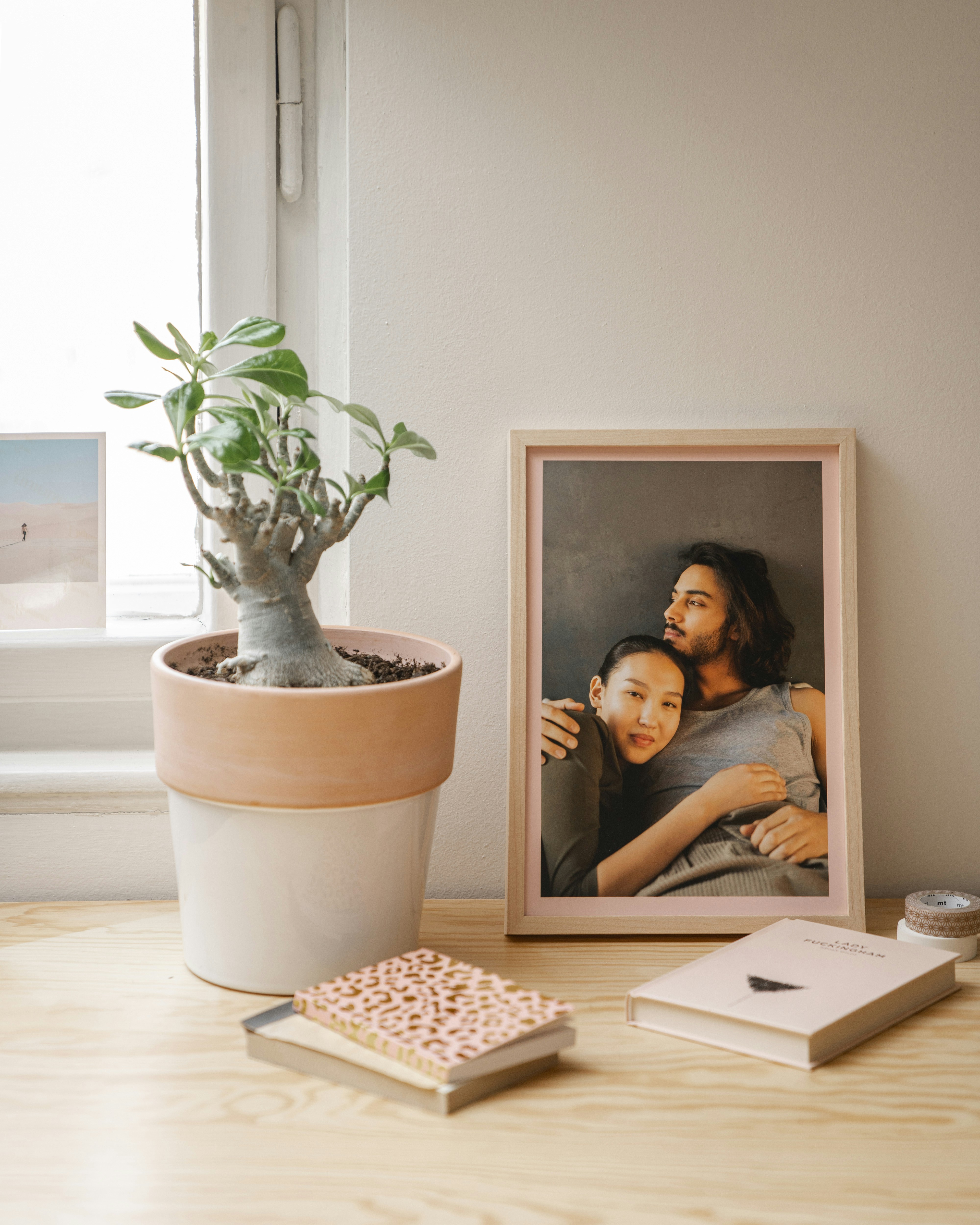 Framed Intimacy: A Couple's Portrait by a Potted Bonsai