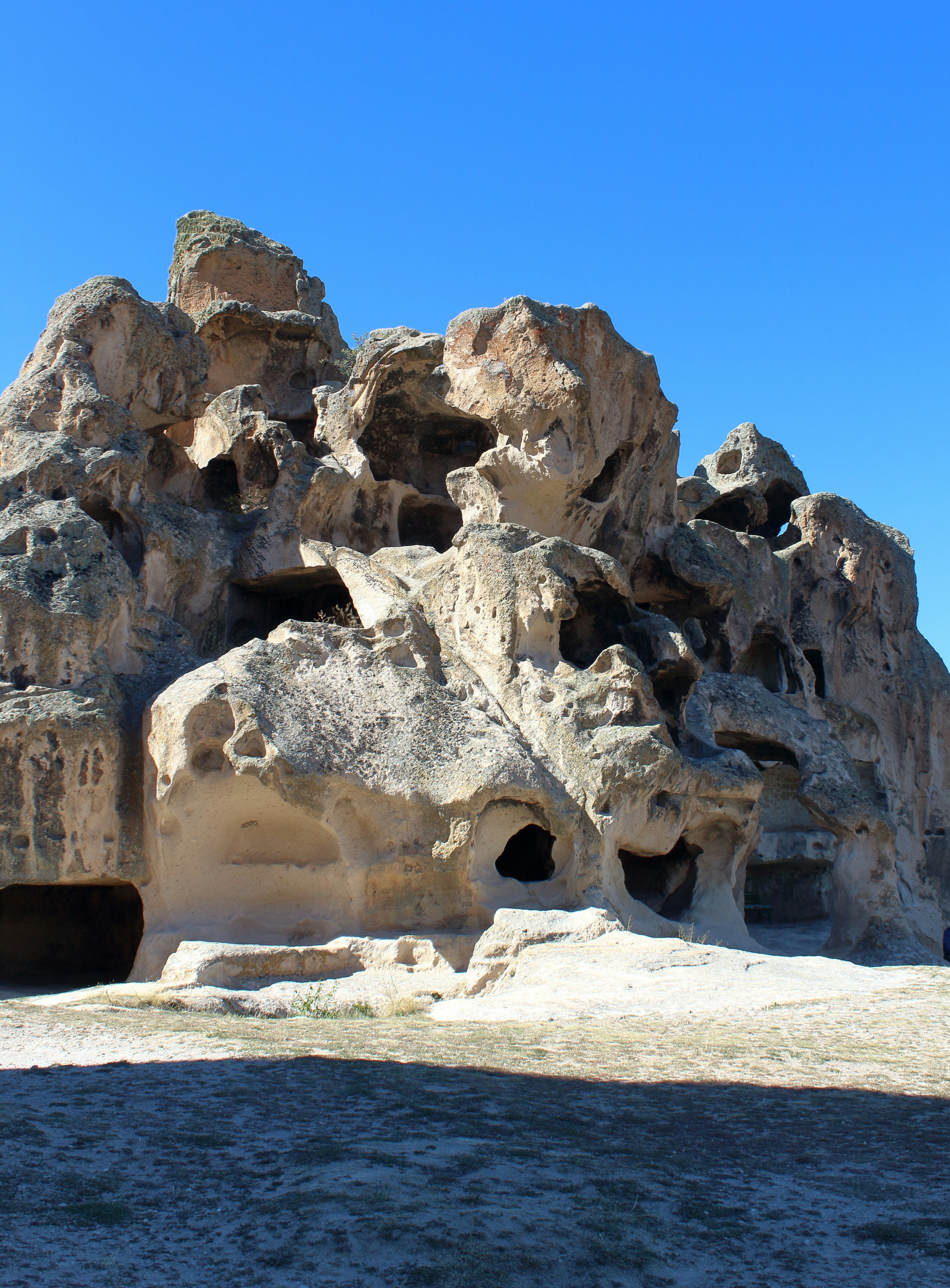 A rocky outcropping with a cave in the middle photo – Free Sea Image on ...