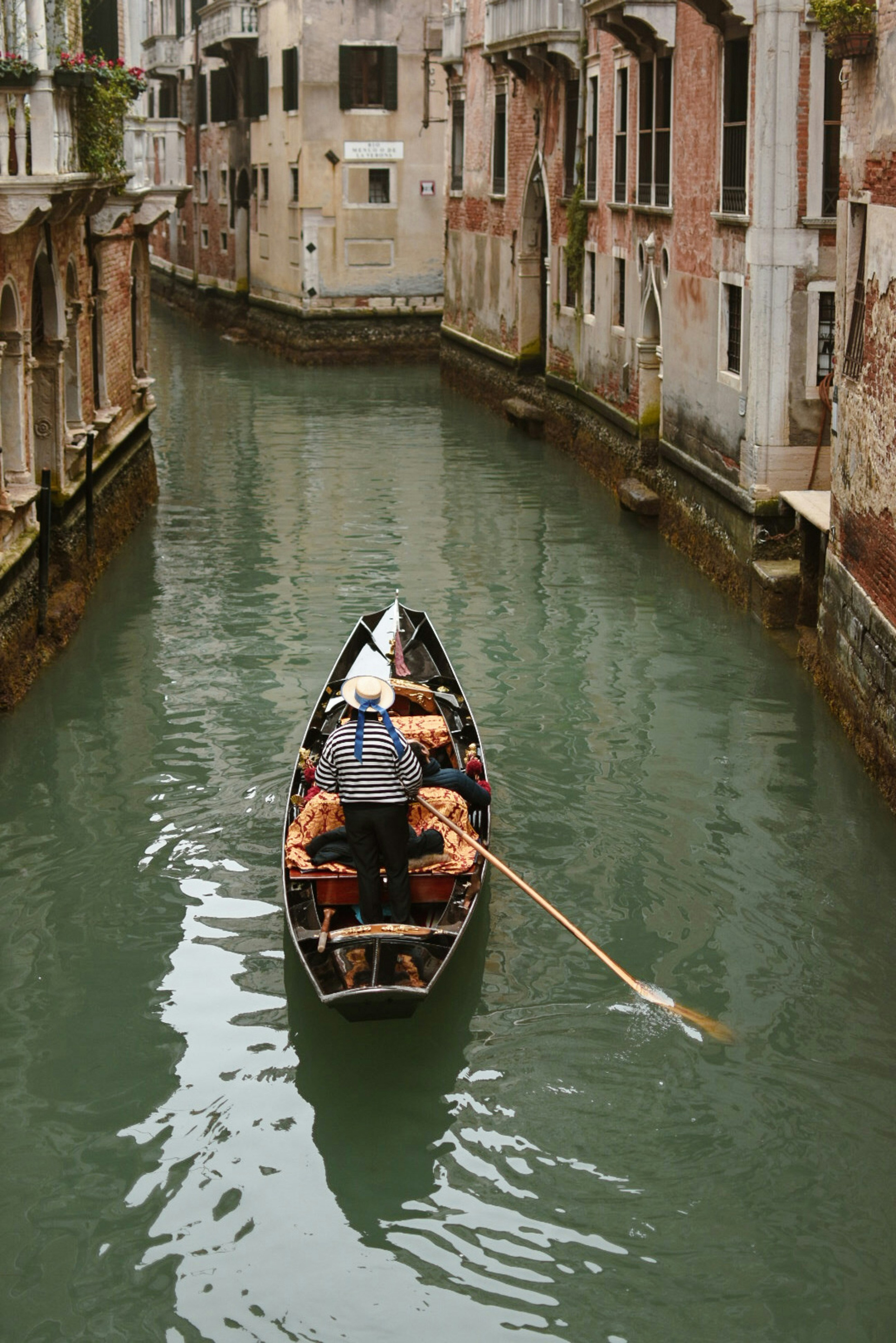 Gondola Drift Through a Venetian Canal Between Weathered Facades