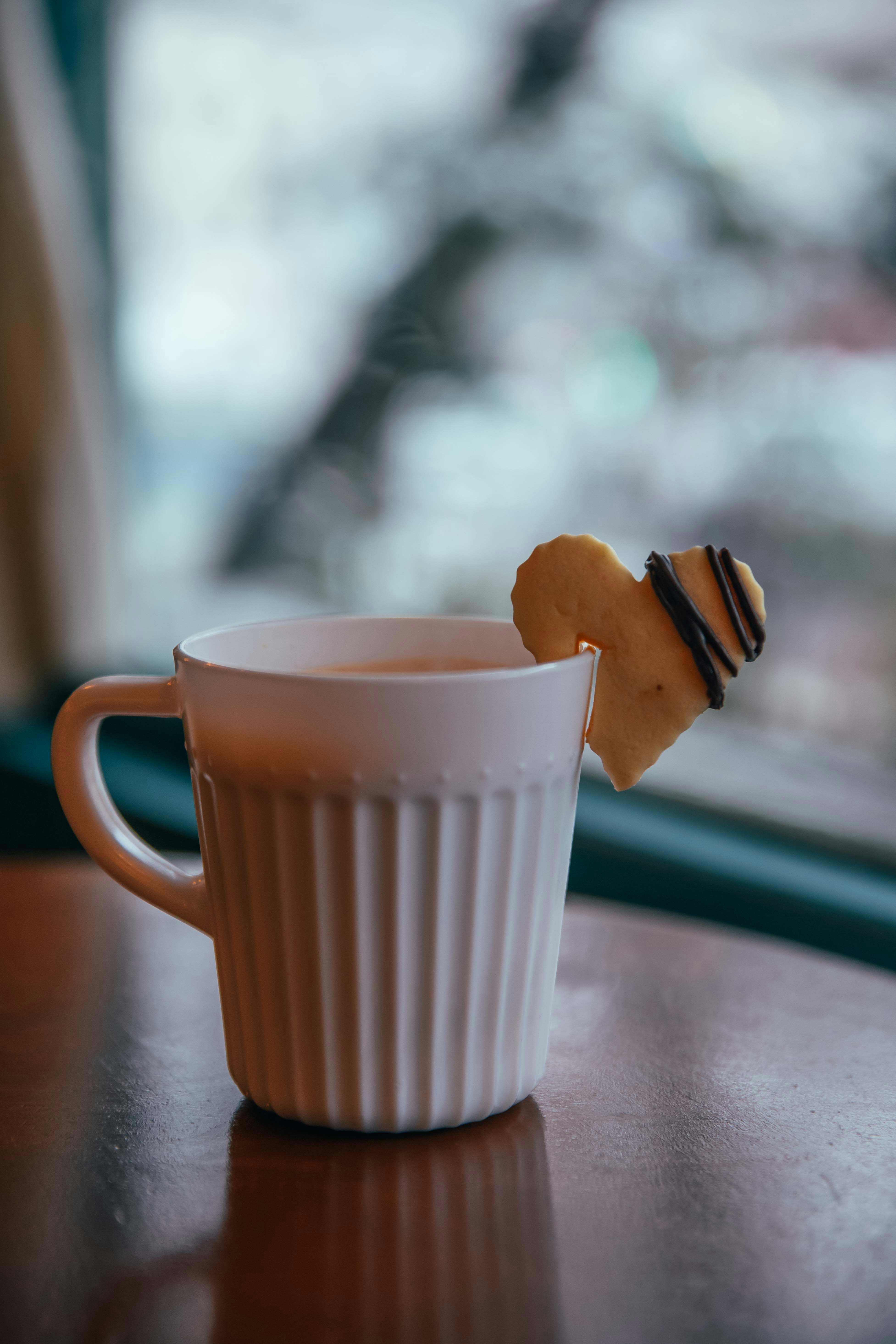 Cookie on the Rim: A Quiet Morning Mug in Soft Café Light