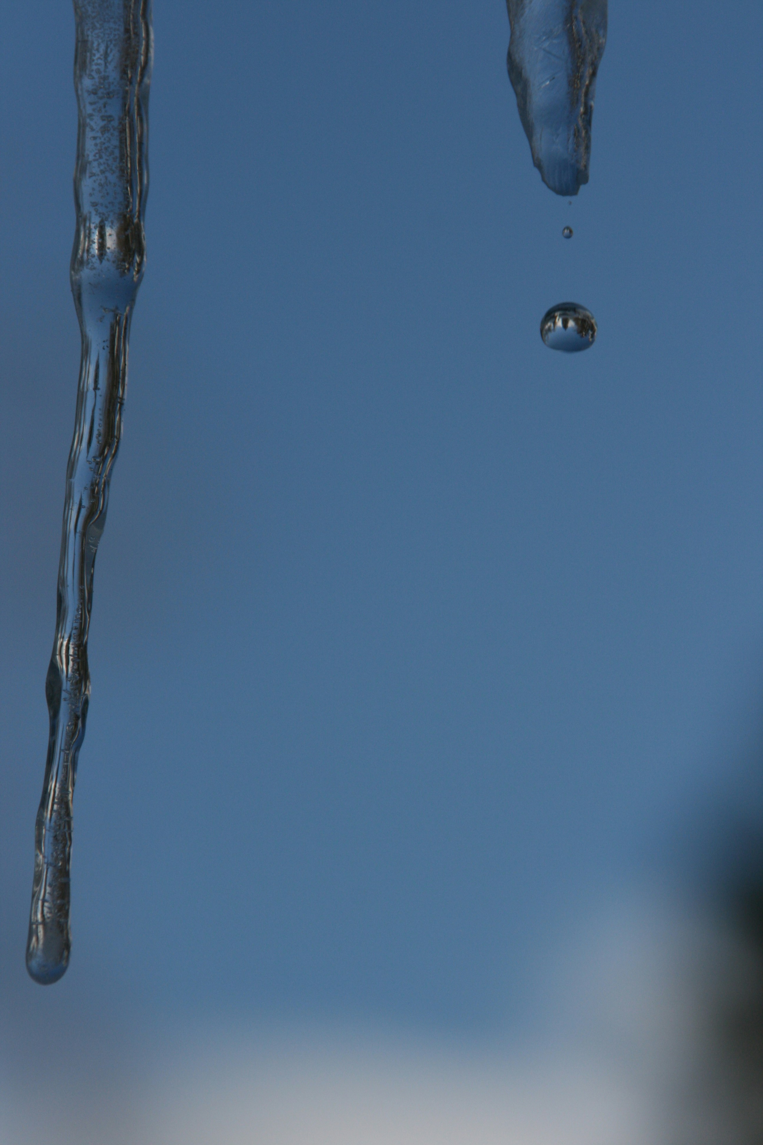 A group of ice hanging from the side of a building photo – Free Icicle ...