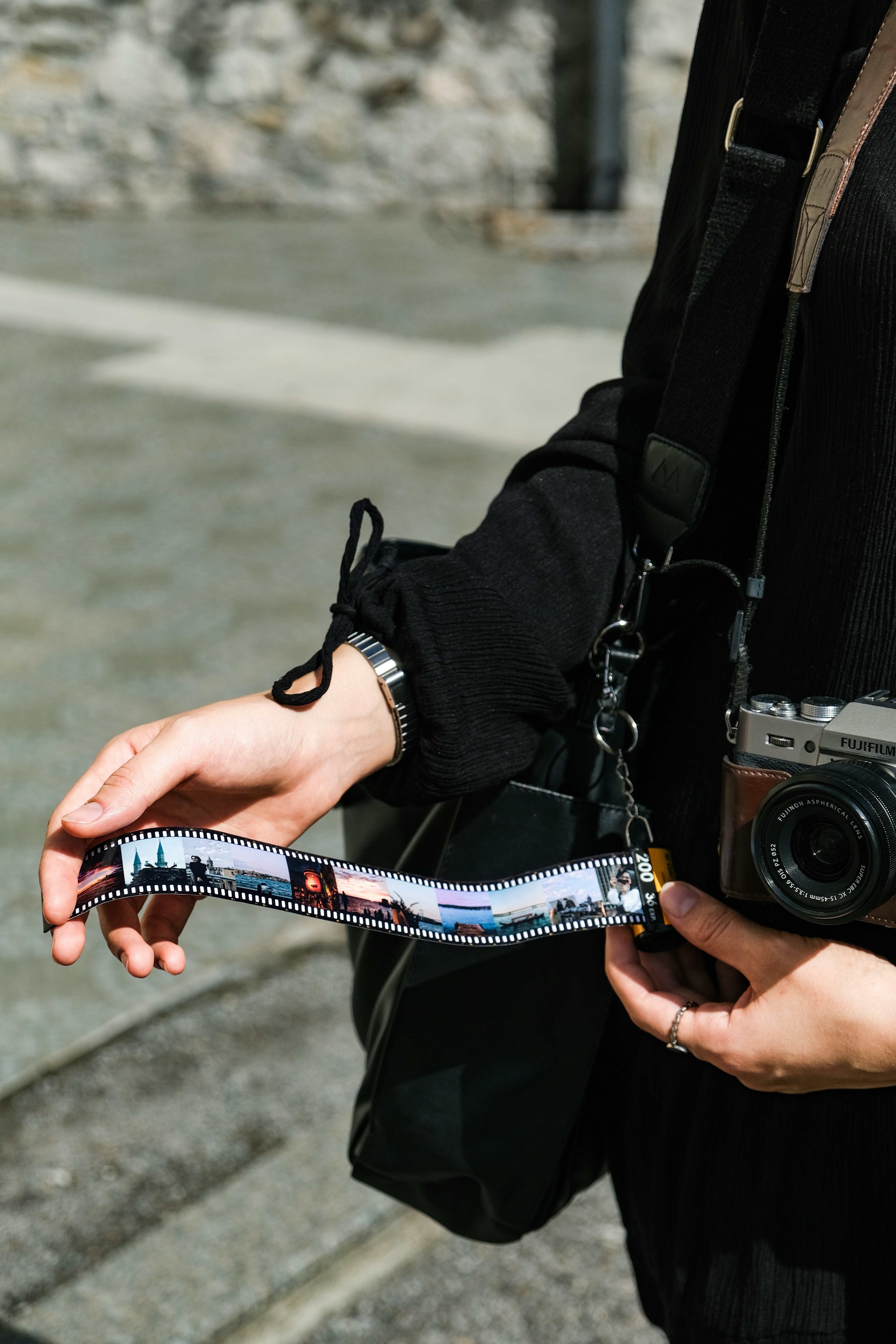 Holding Time: A Curved Film Strip and a Camera in Frame