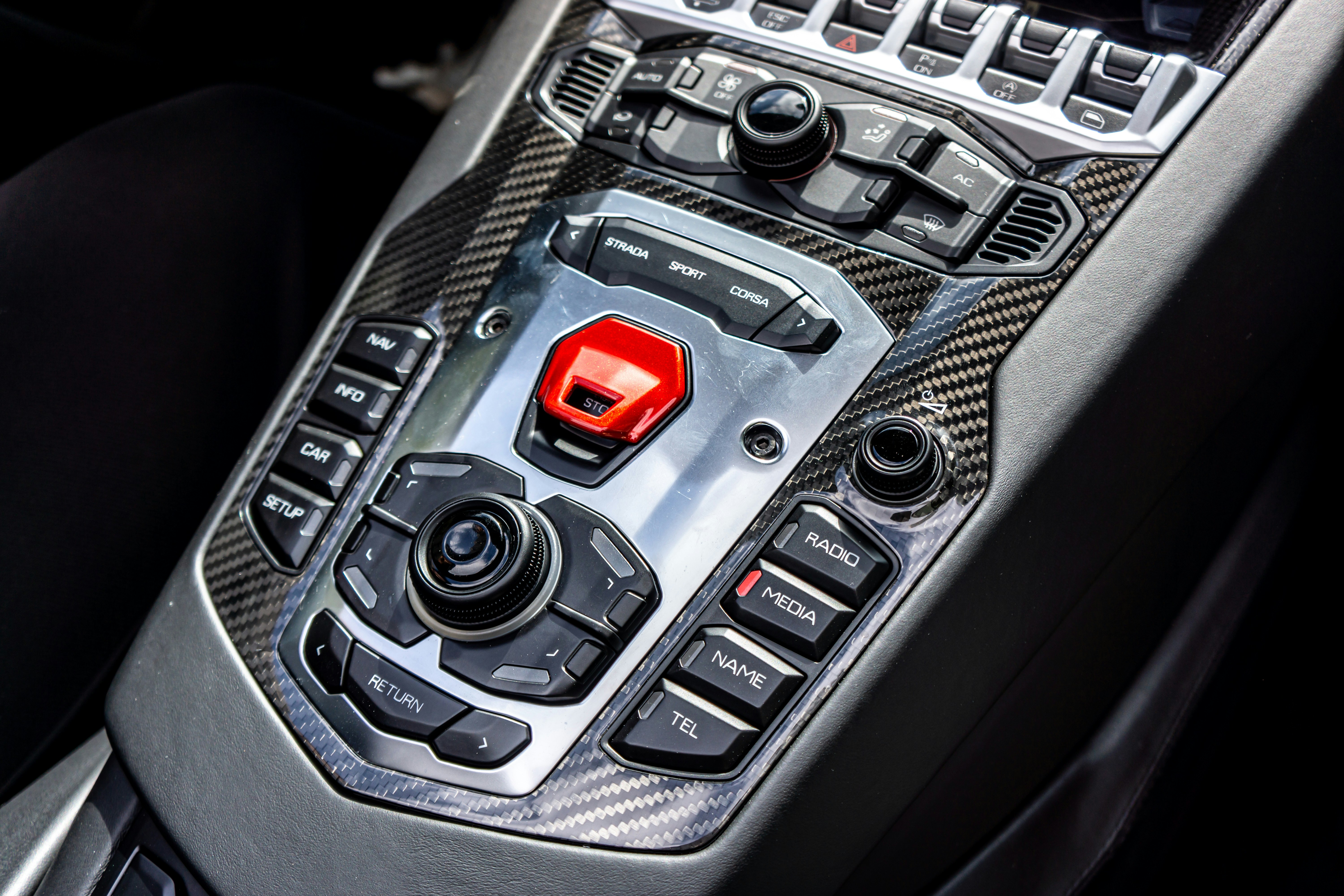 A close up of a car dashboard with a red button photo – Free ...