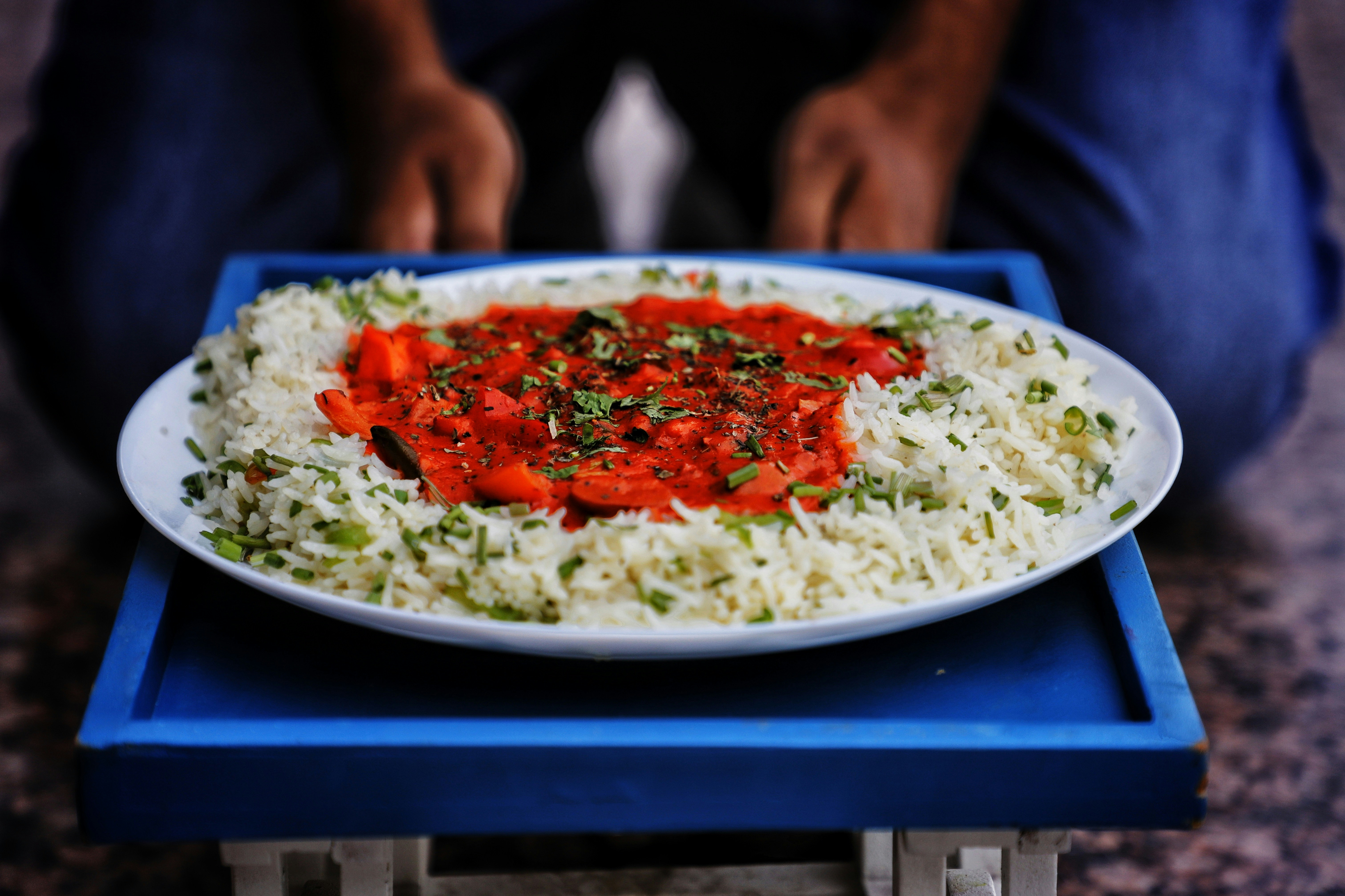 Crimson Crown on a Cobalt Stage: Rice Platter on a Raised Blue Tray