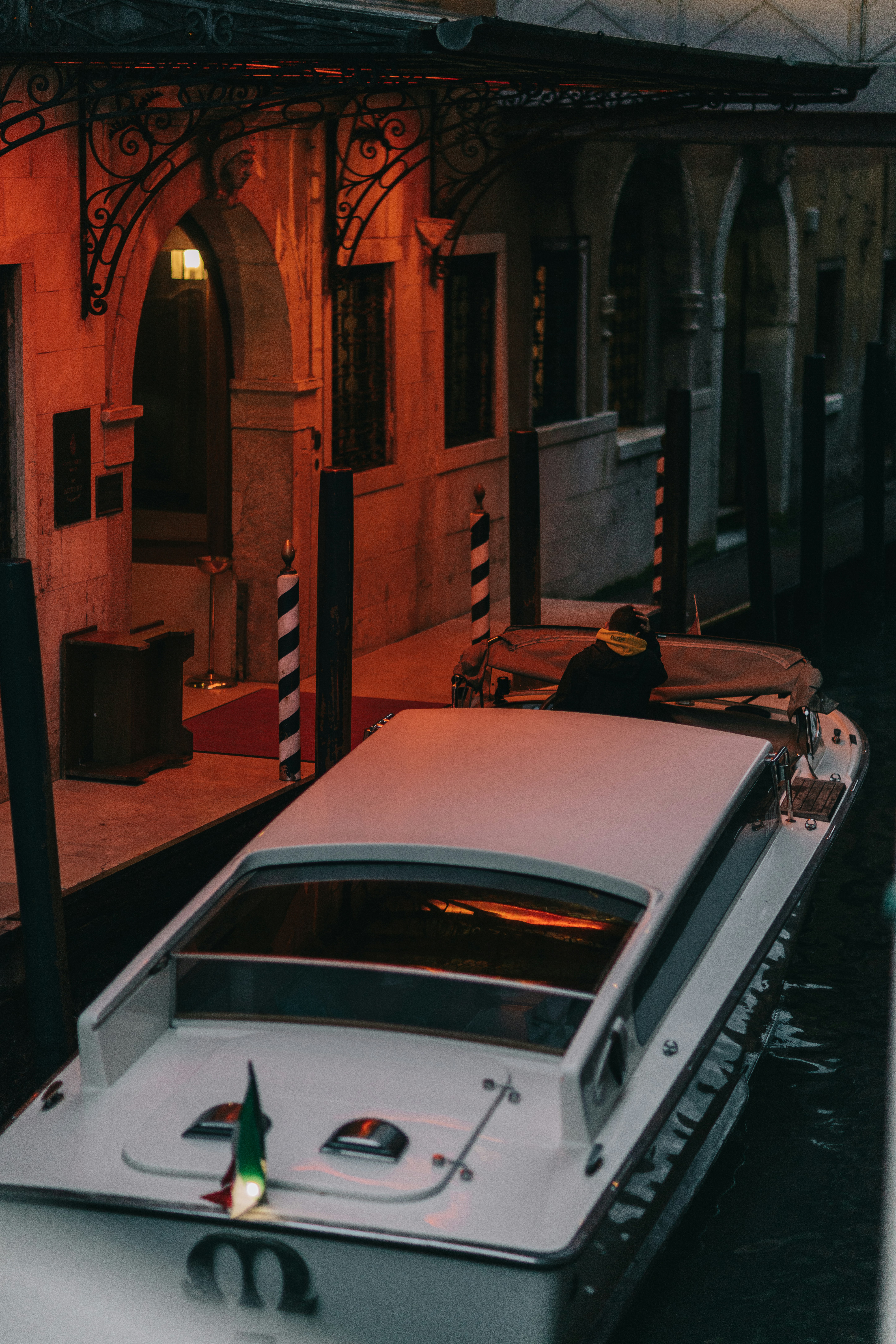 Amber Arches and a Quiet Mooring: A White Boat Resting Along a Venetian Canal at Dusk