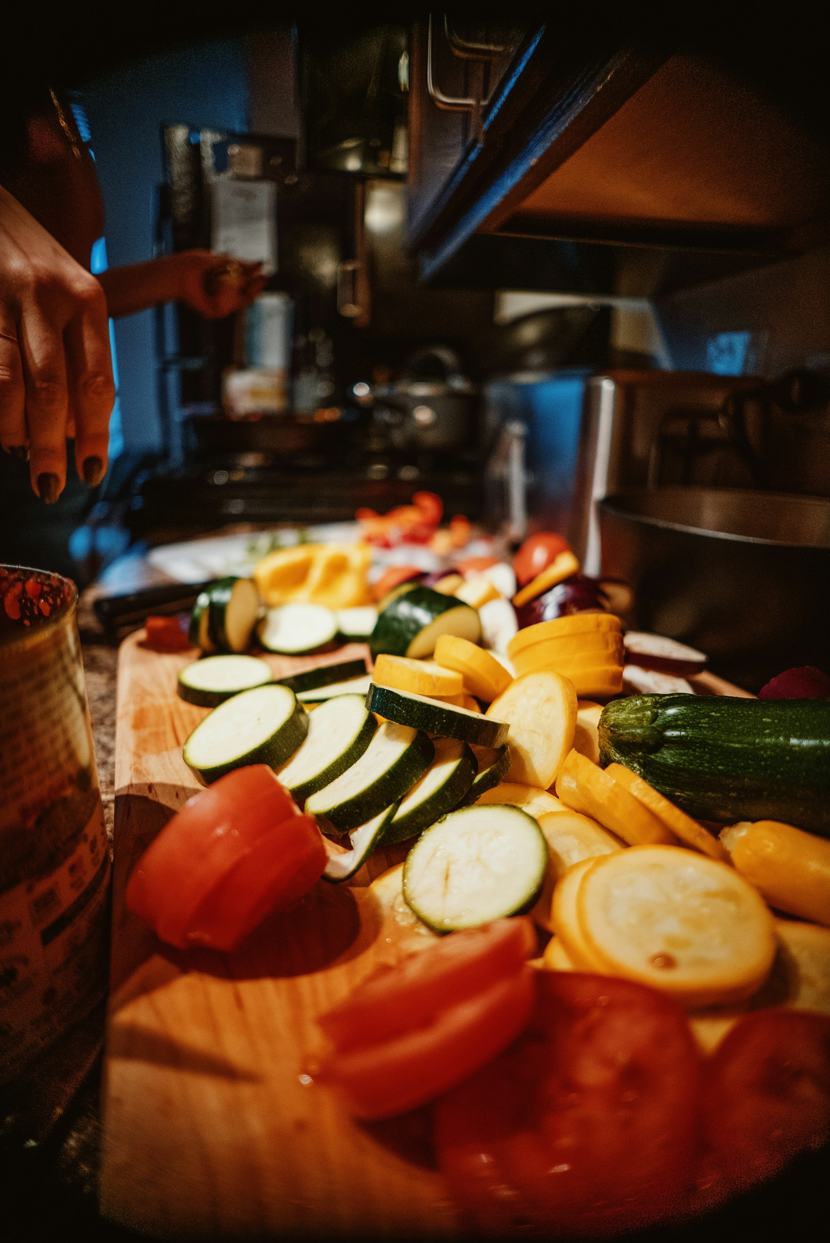 Midnight Mise en Place: A Colorful Parade of Veggie Slices on a Wooden Board