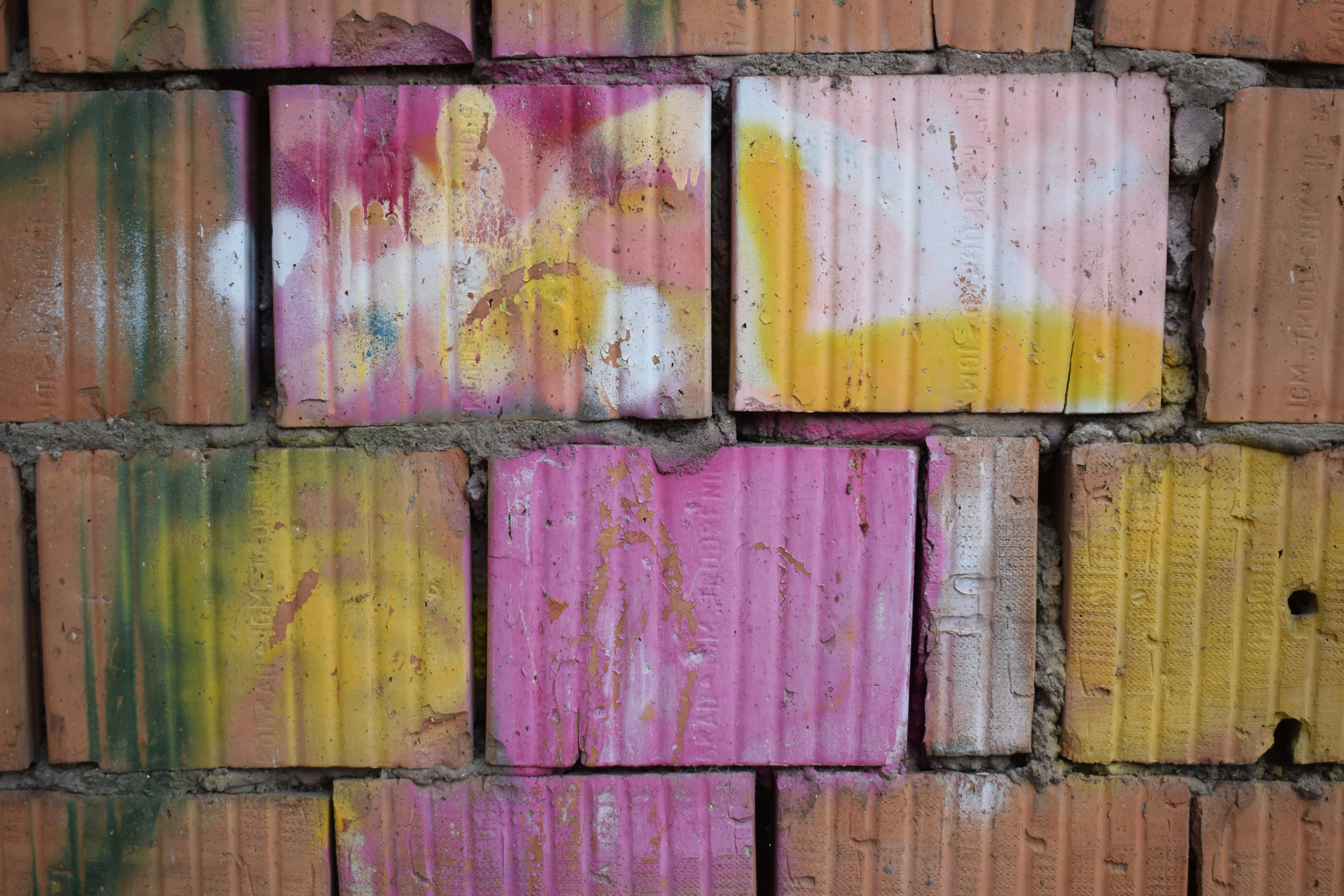 a close up of a brick wall with graffiti on it