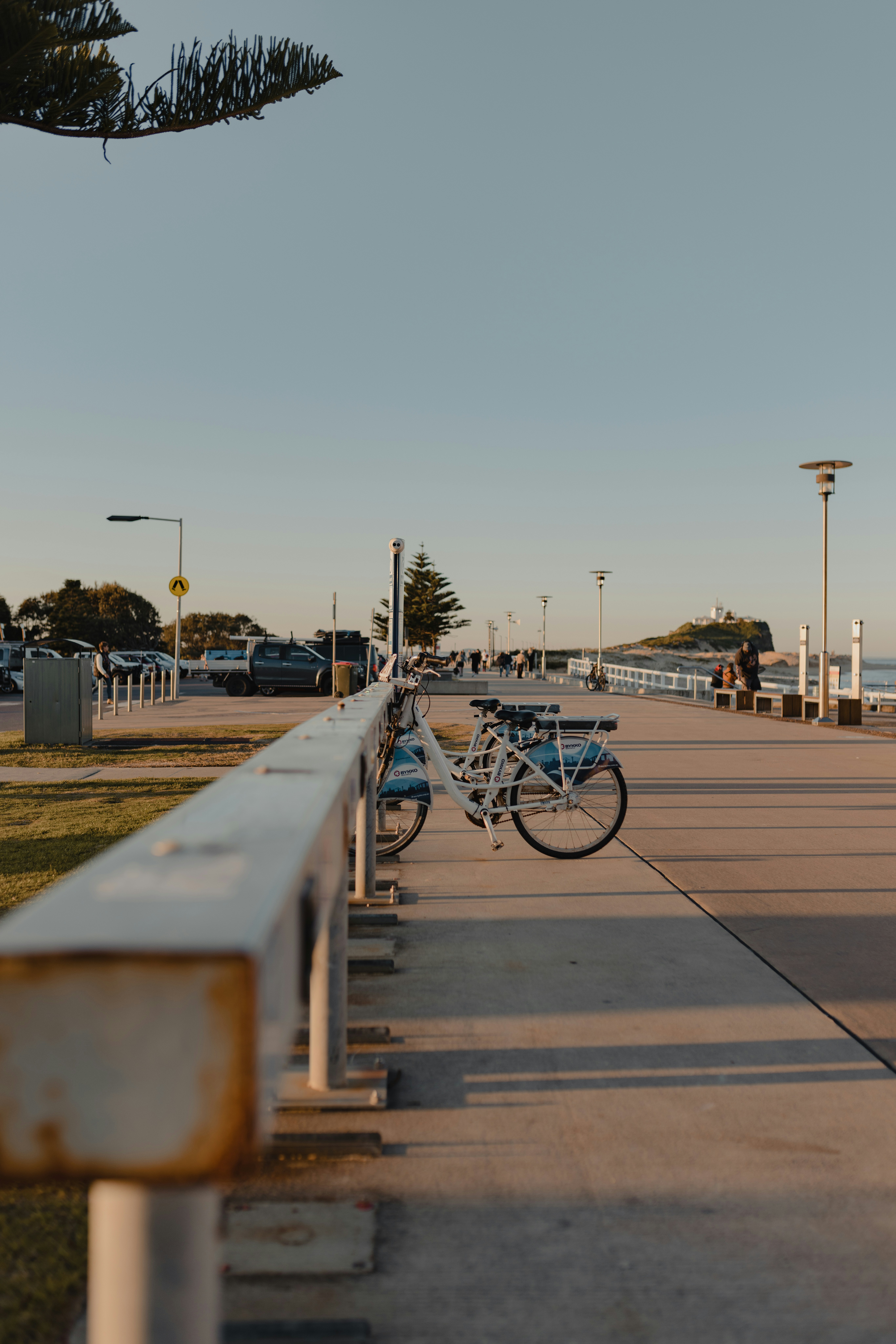 a row of bikes parked next to each other on a sidewalk