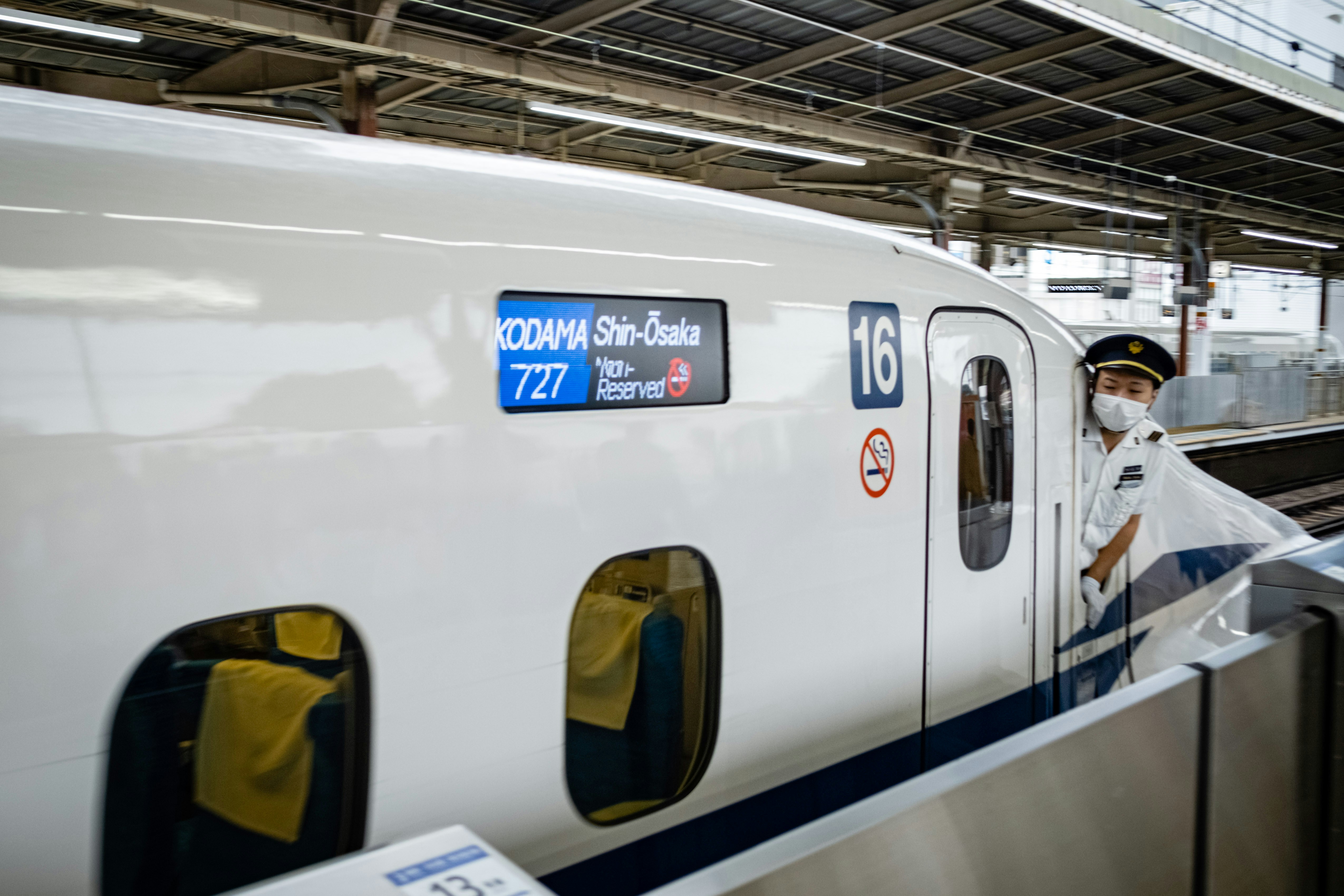 Masked Conductor at the Platform: A White High-Speed Train