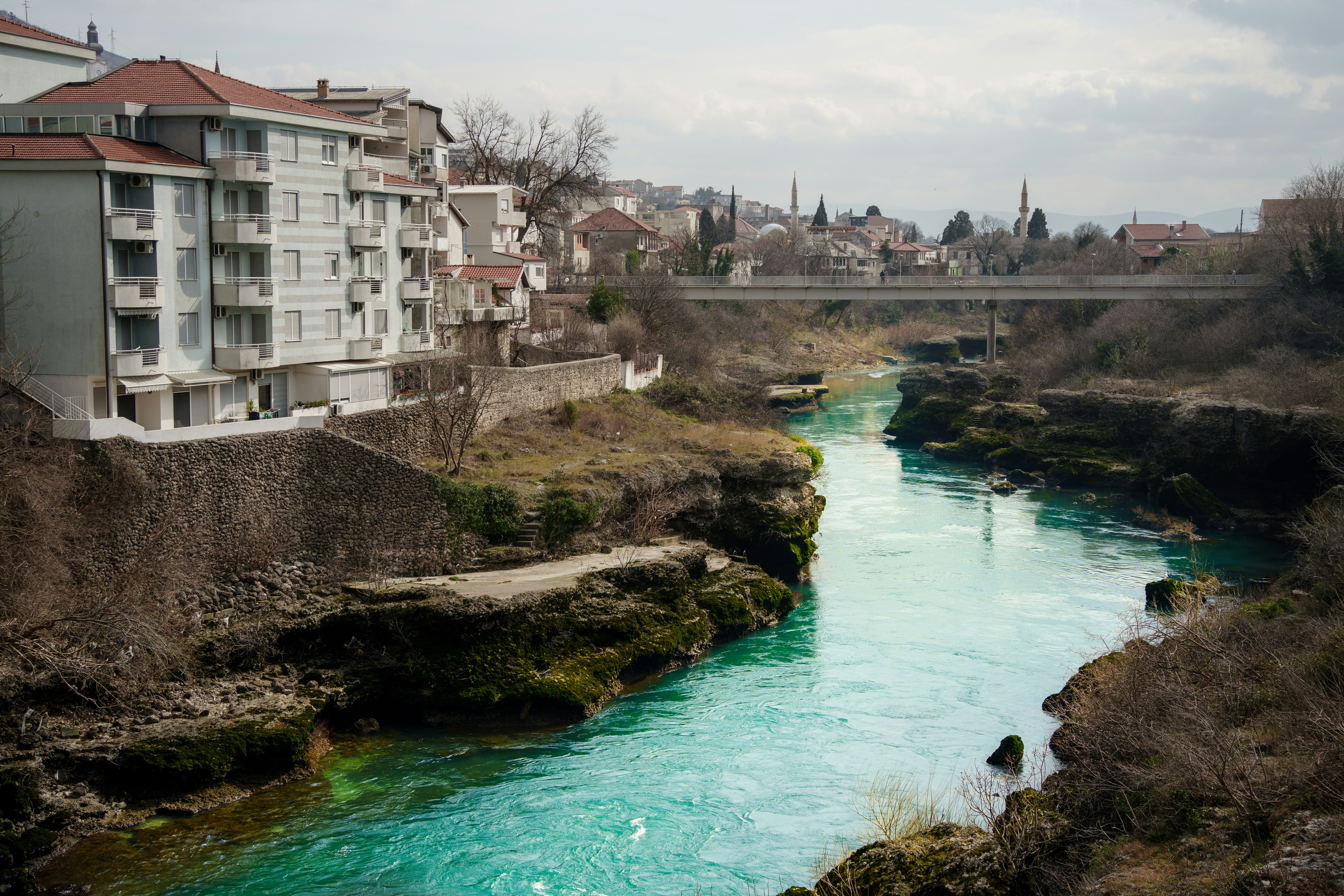 A river running through a city next to tall buildings photo – Free ...