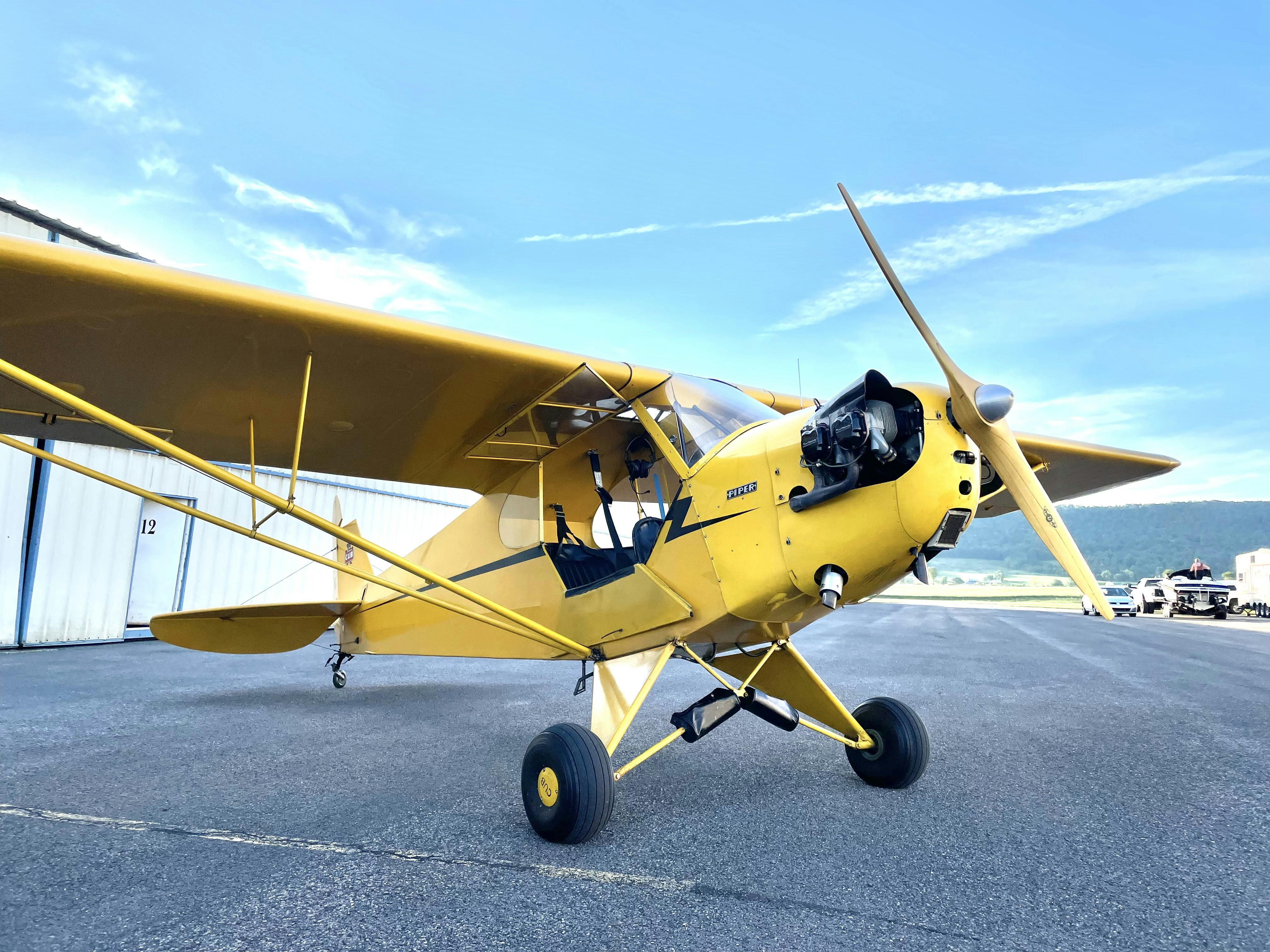 A small yellow airplane sitting on top of an airport tarmac photo ...