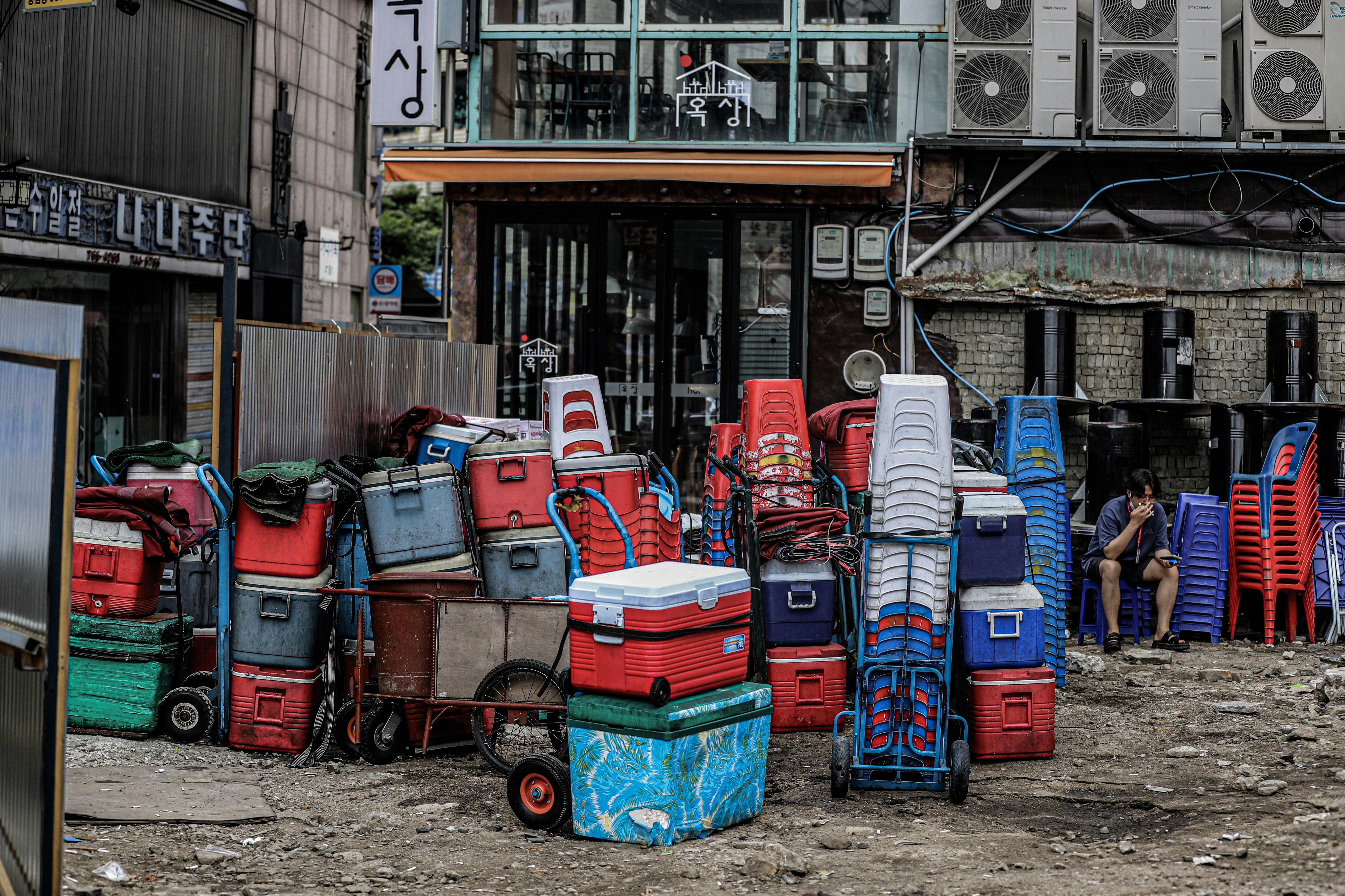 A pile of luggage sitting in front of a building photo – Free Ikseon ...