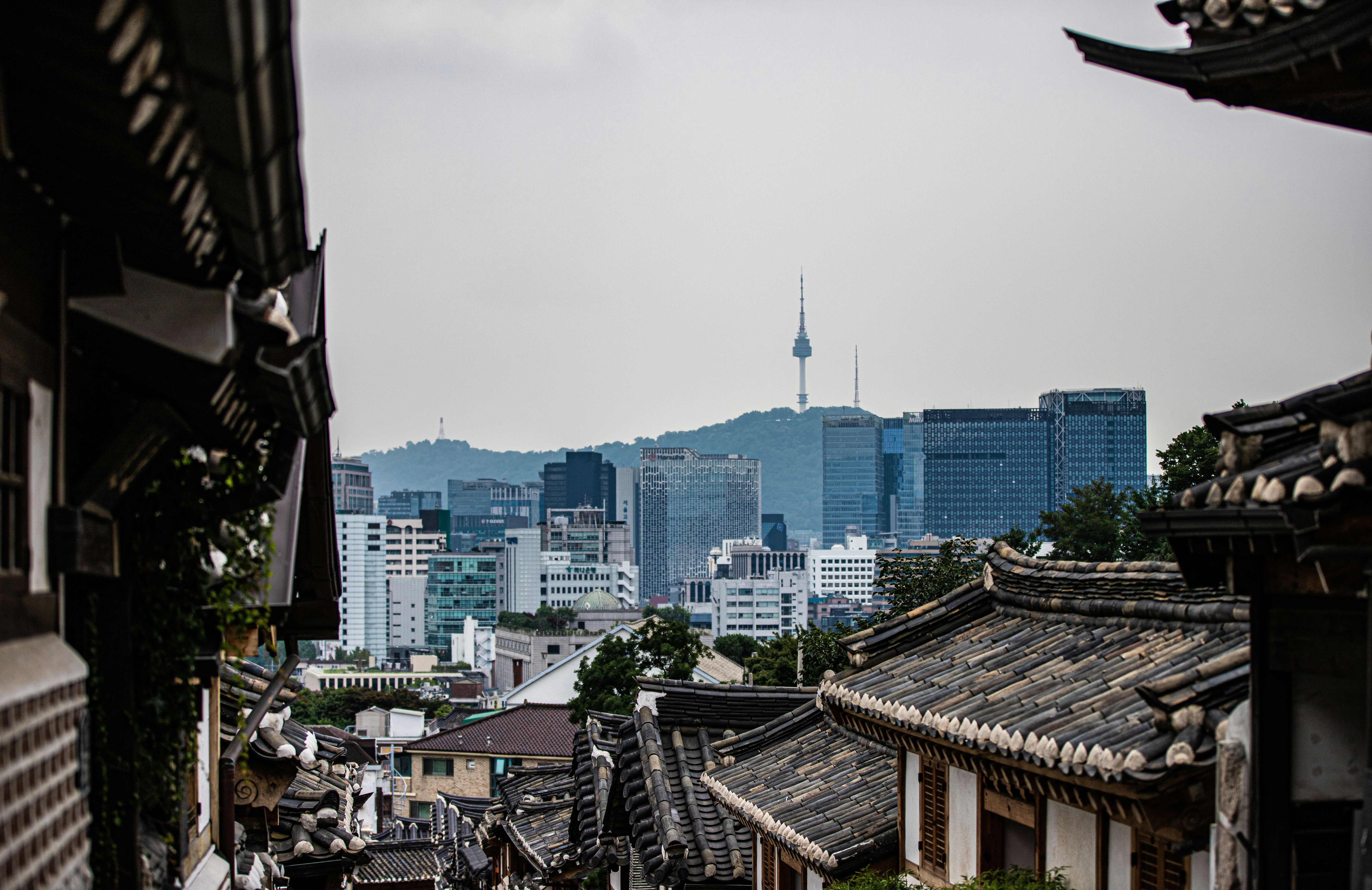 A view of a city with tall buildings photo – Free Bukchon hanok village ...