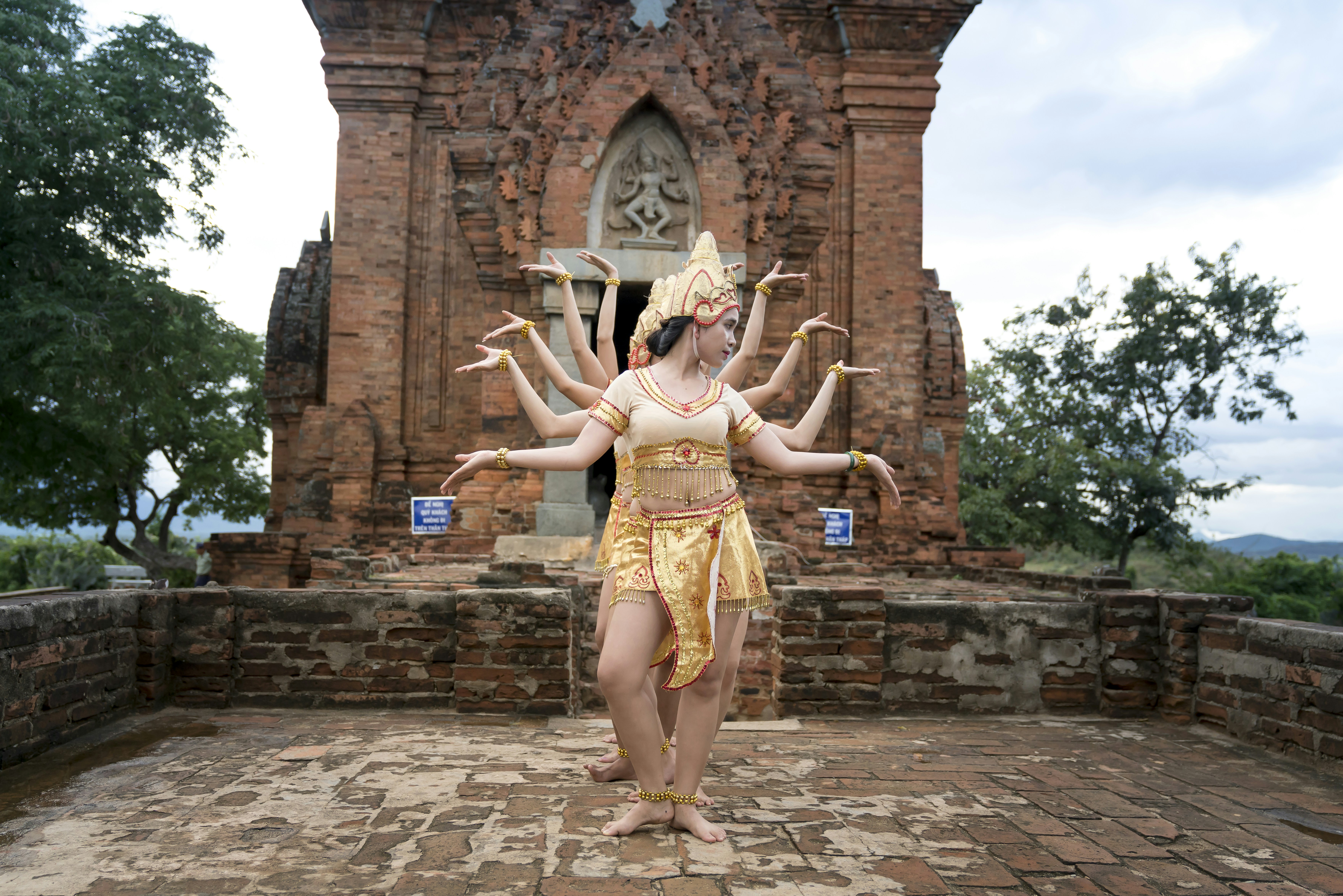 Nine-Armed Grace in a Red Brick Temple Courtyard