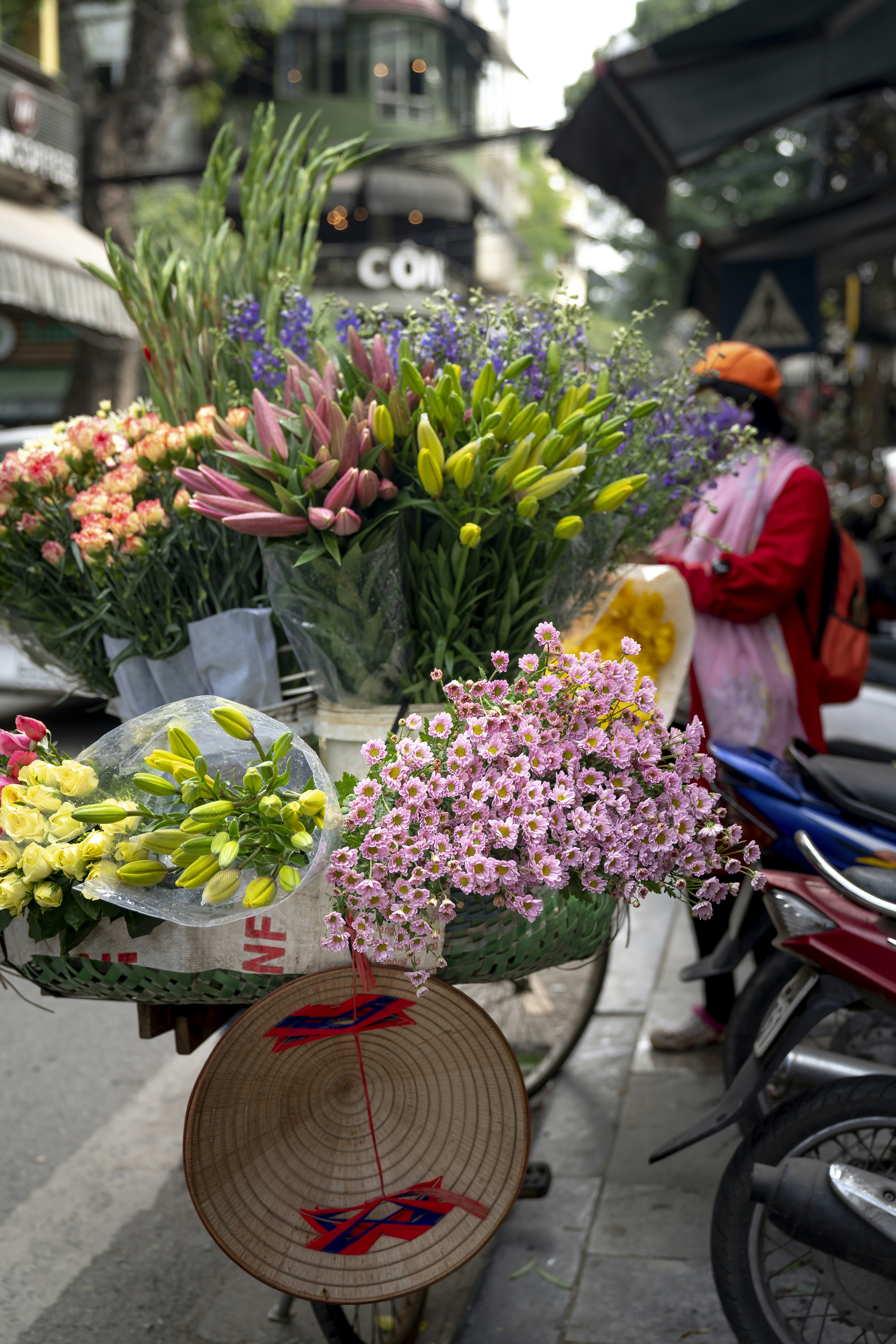 a bicycle with a bunch of flowers on the back of it
