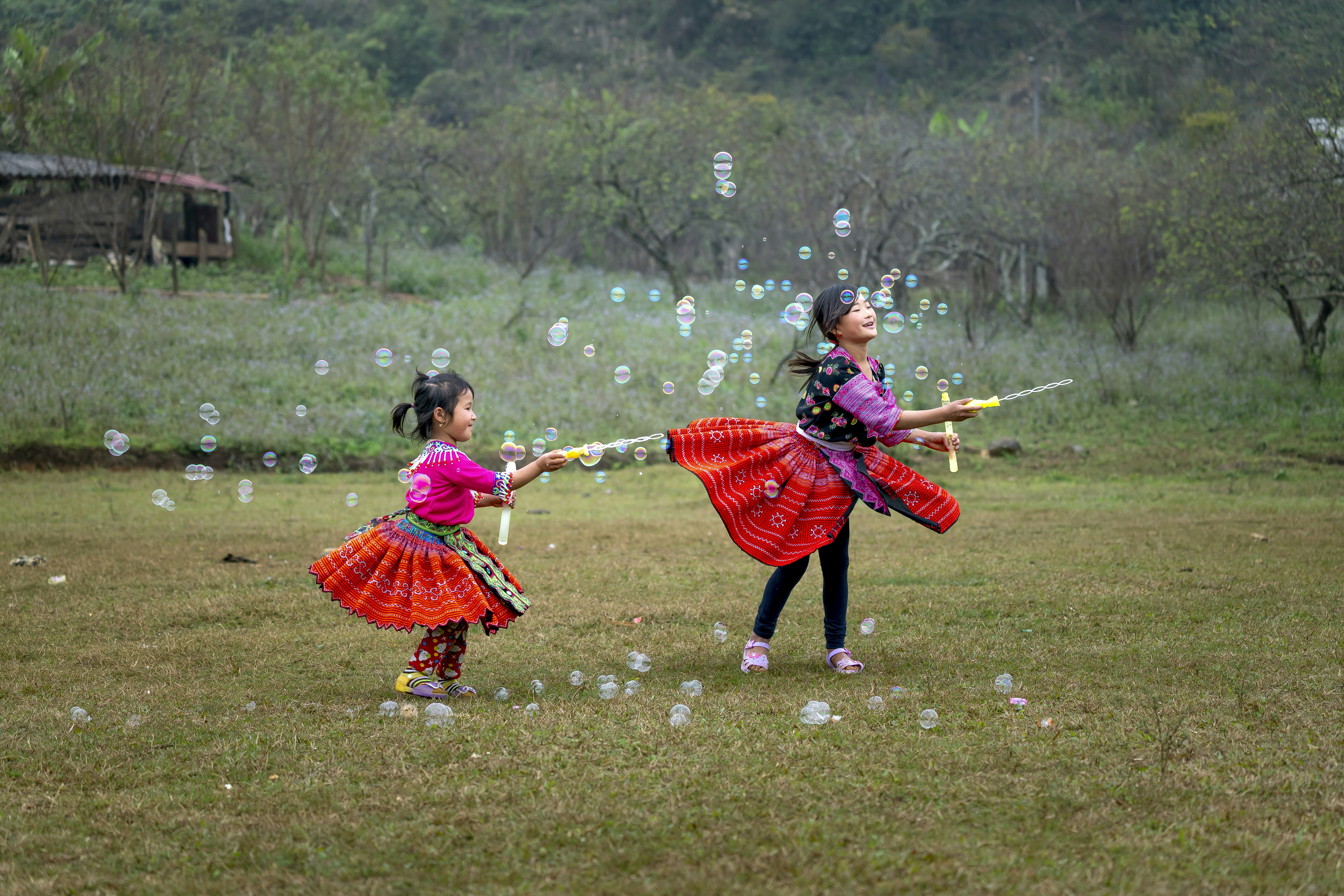 Bubble Ballet in a Sunlit Meadow: Two Dancers in Colorful Skirts
