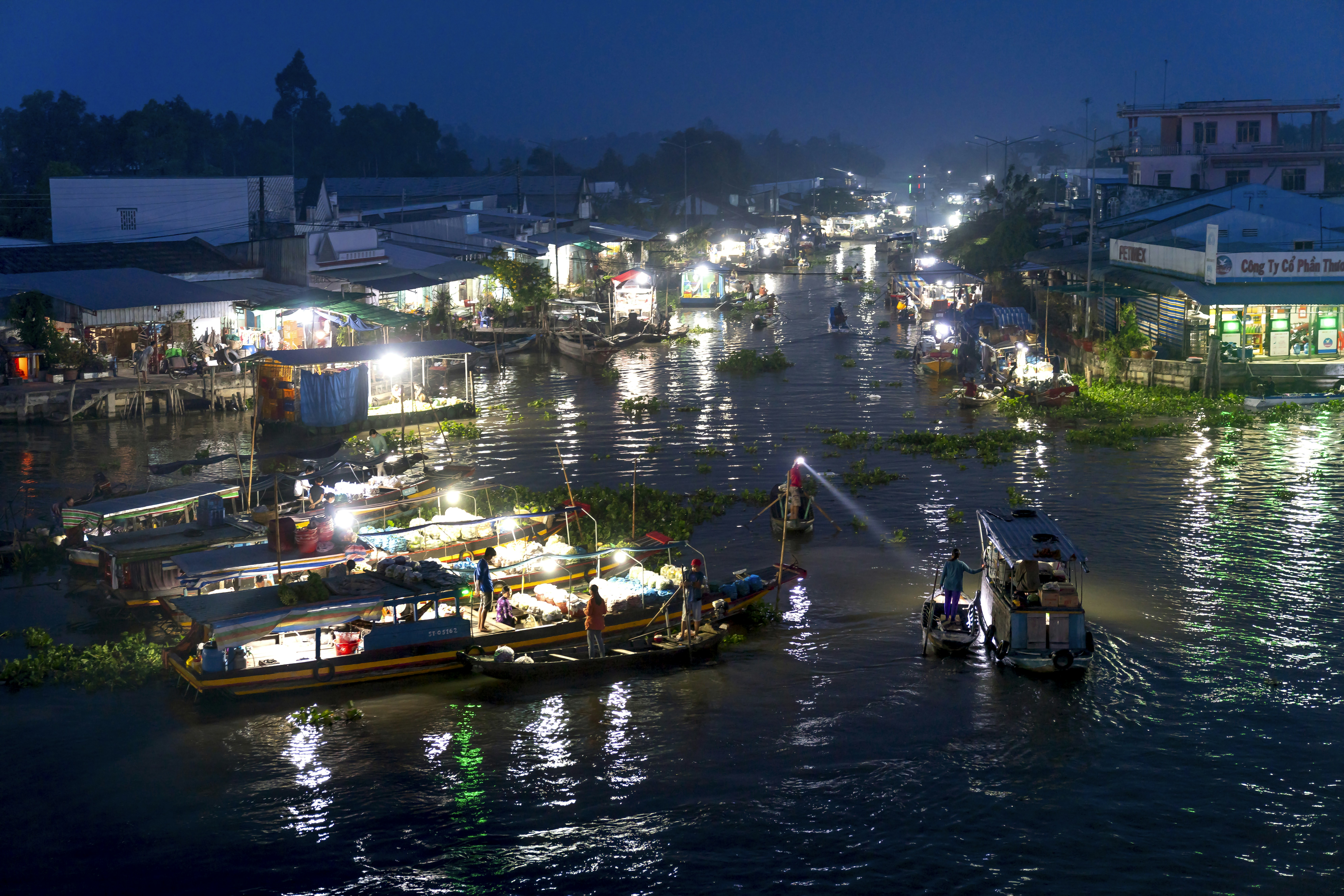 A group of boats floating down a river at night photo – Free Water ...