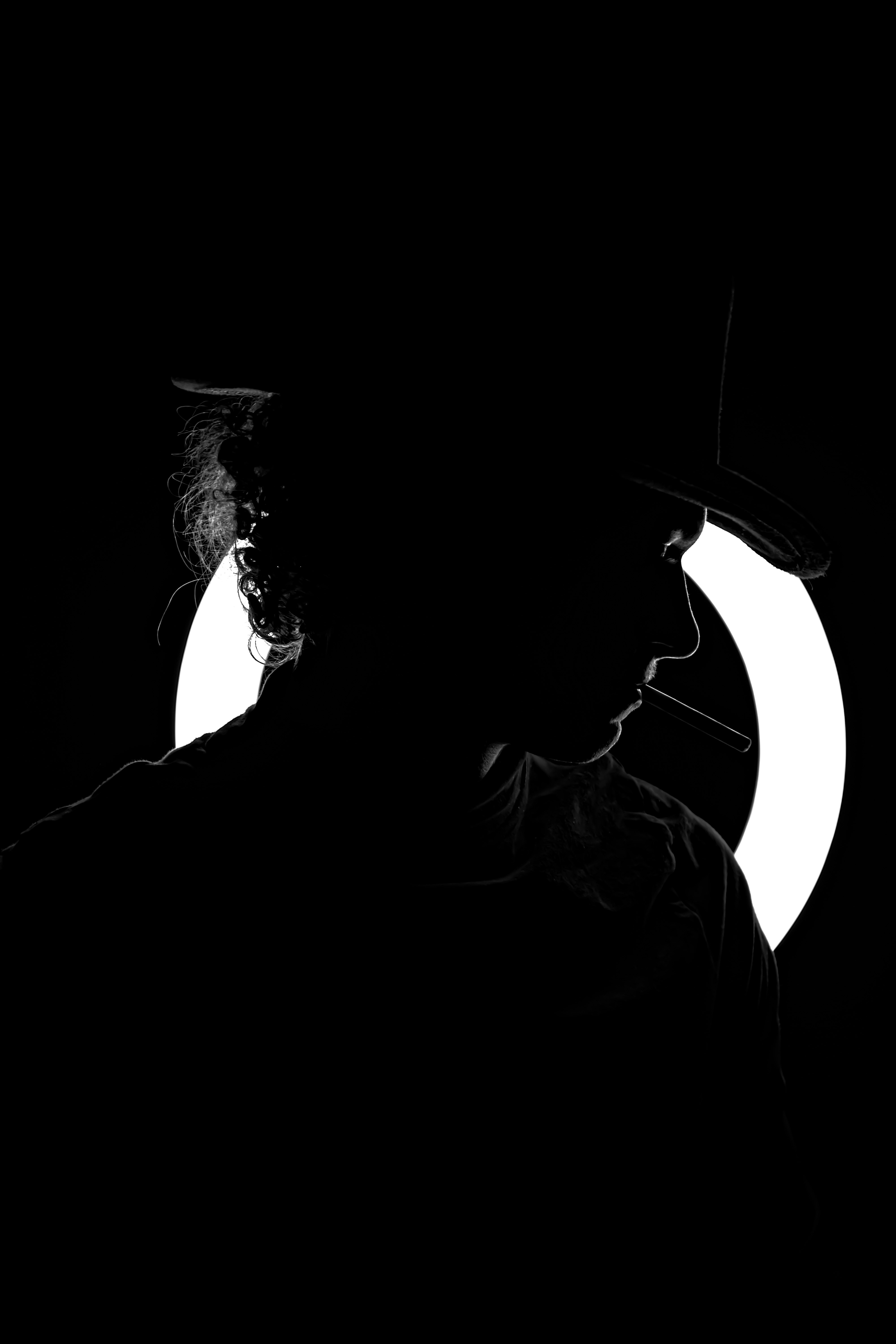 Silhouette of a Cigarette-Holdered Face in a Lunar Ring