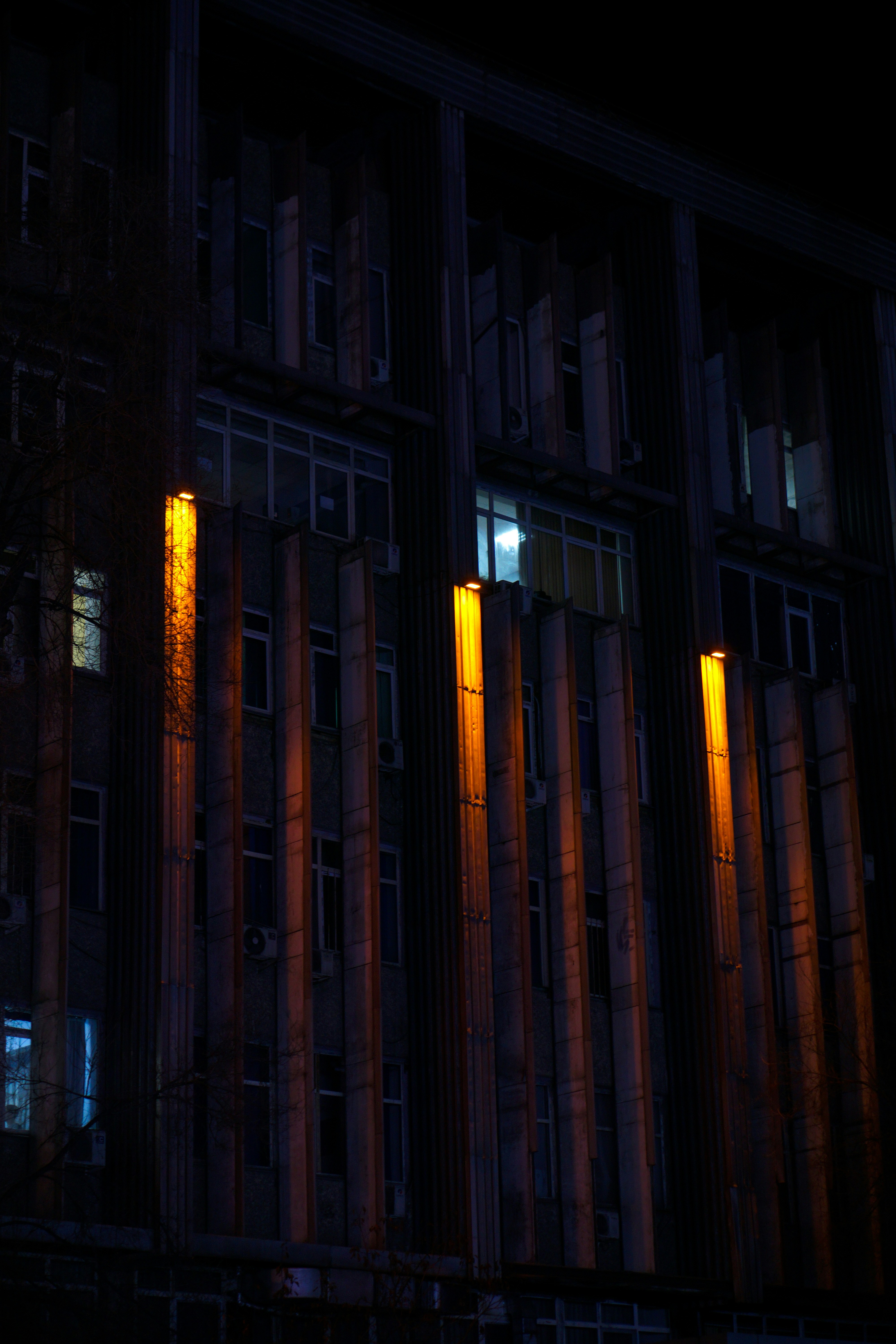 A tall building with many windows lit up at night photo – Free Almaty ...