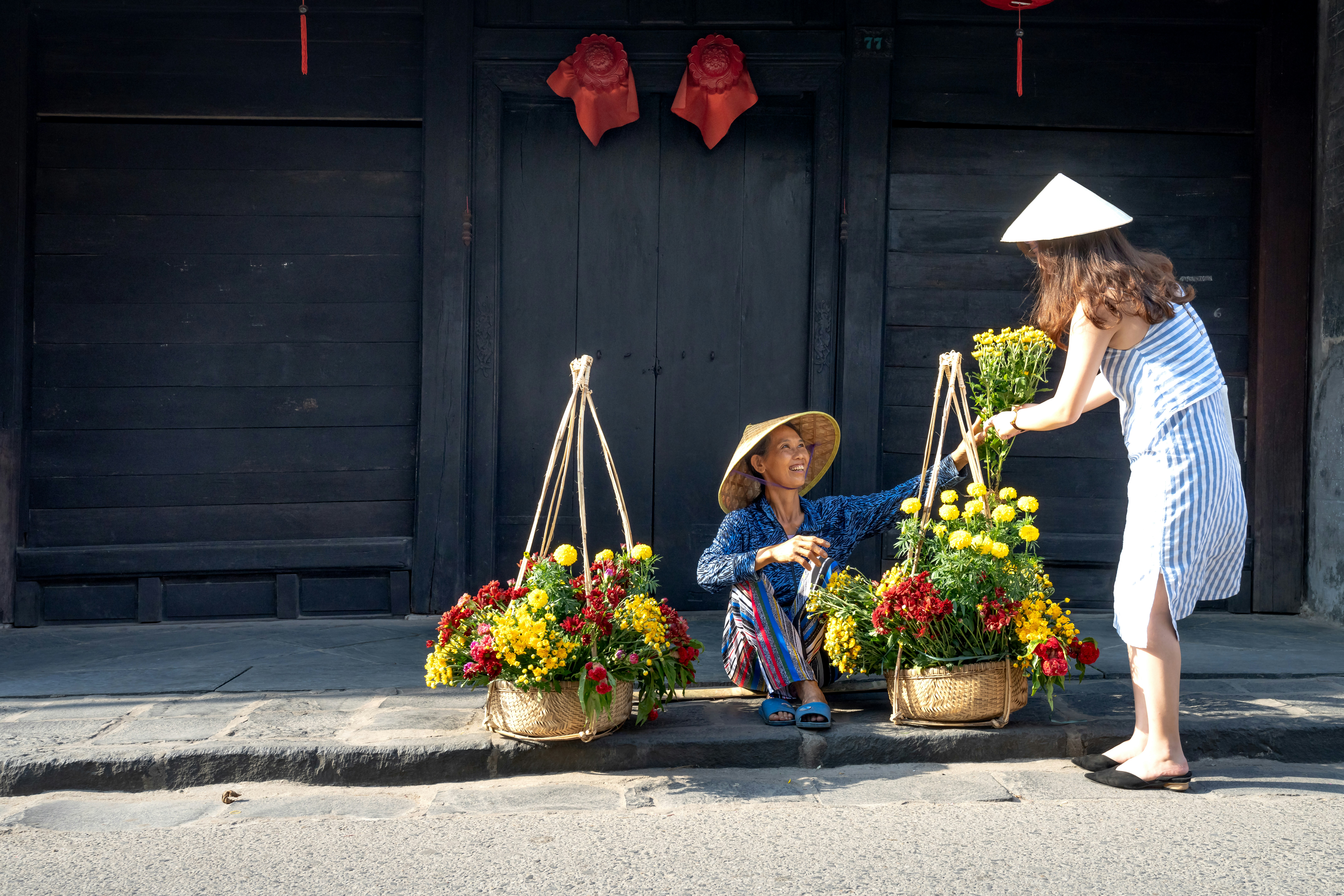 Two women are selling flowers on the street photo – Free Flower Image ...