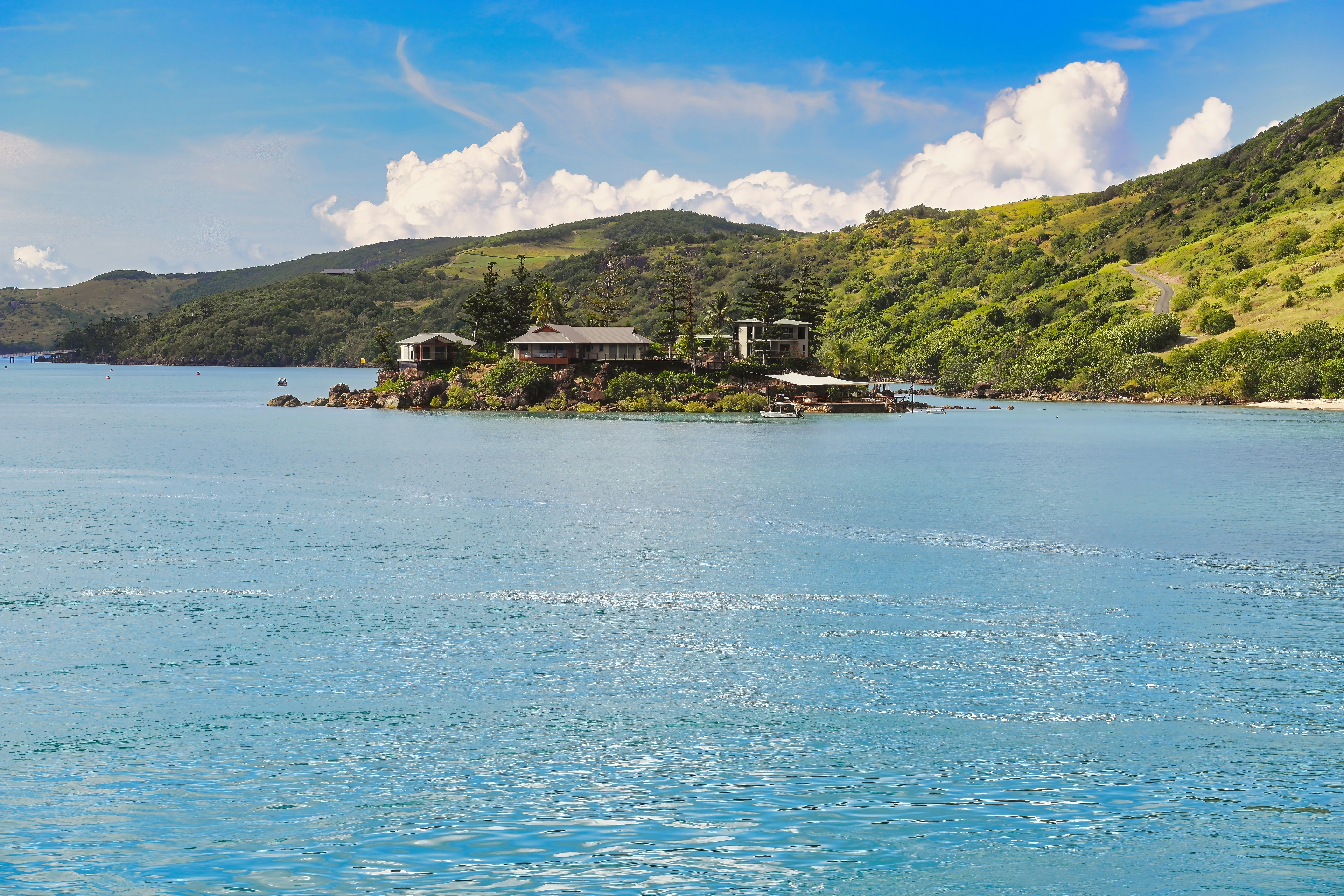 Turquoise Inlet Haven: A Tiny Island Village Nestled Against Green Slopes