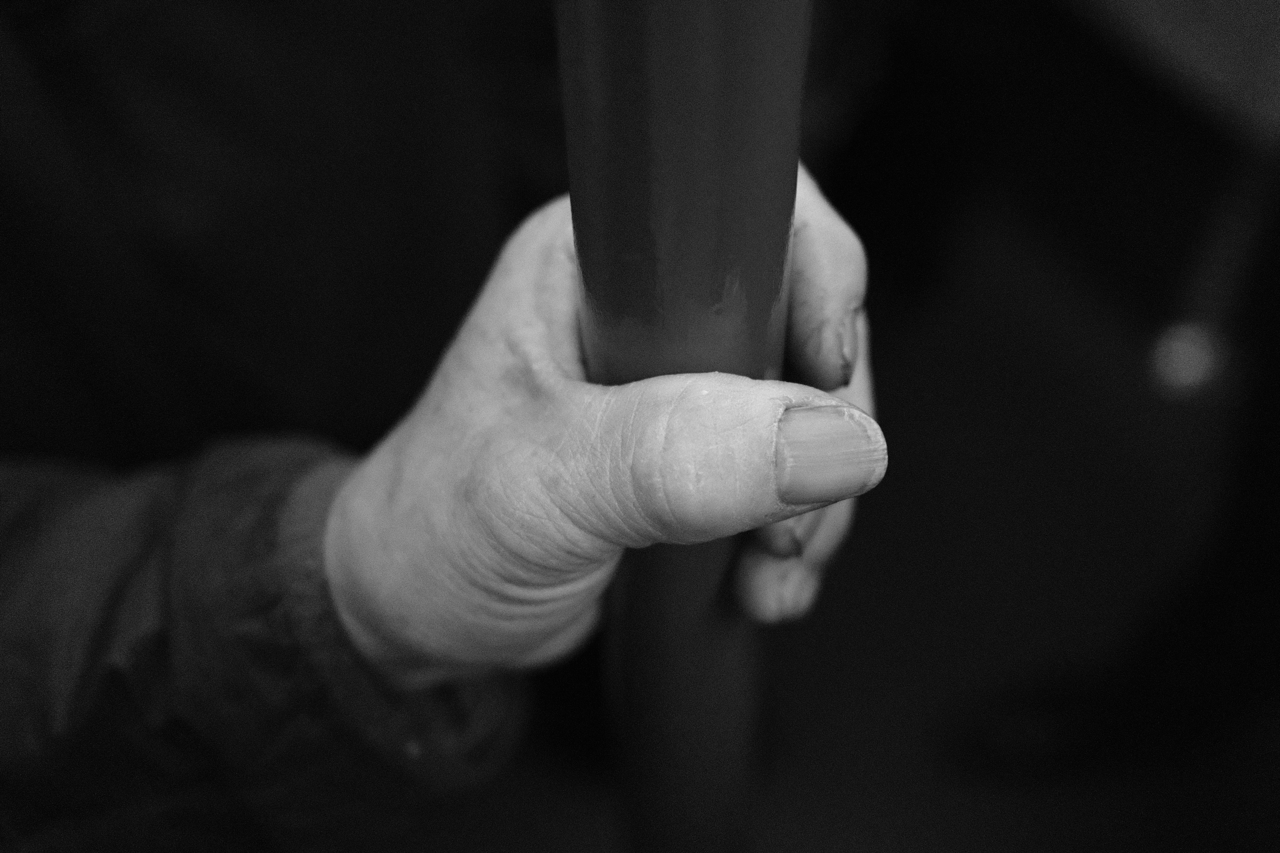 Quiet Grip: A Hand Clasp on a Steel Rail
