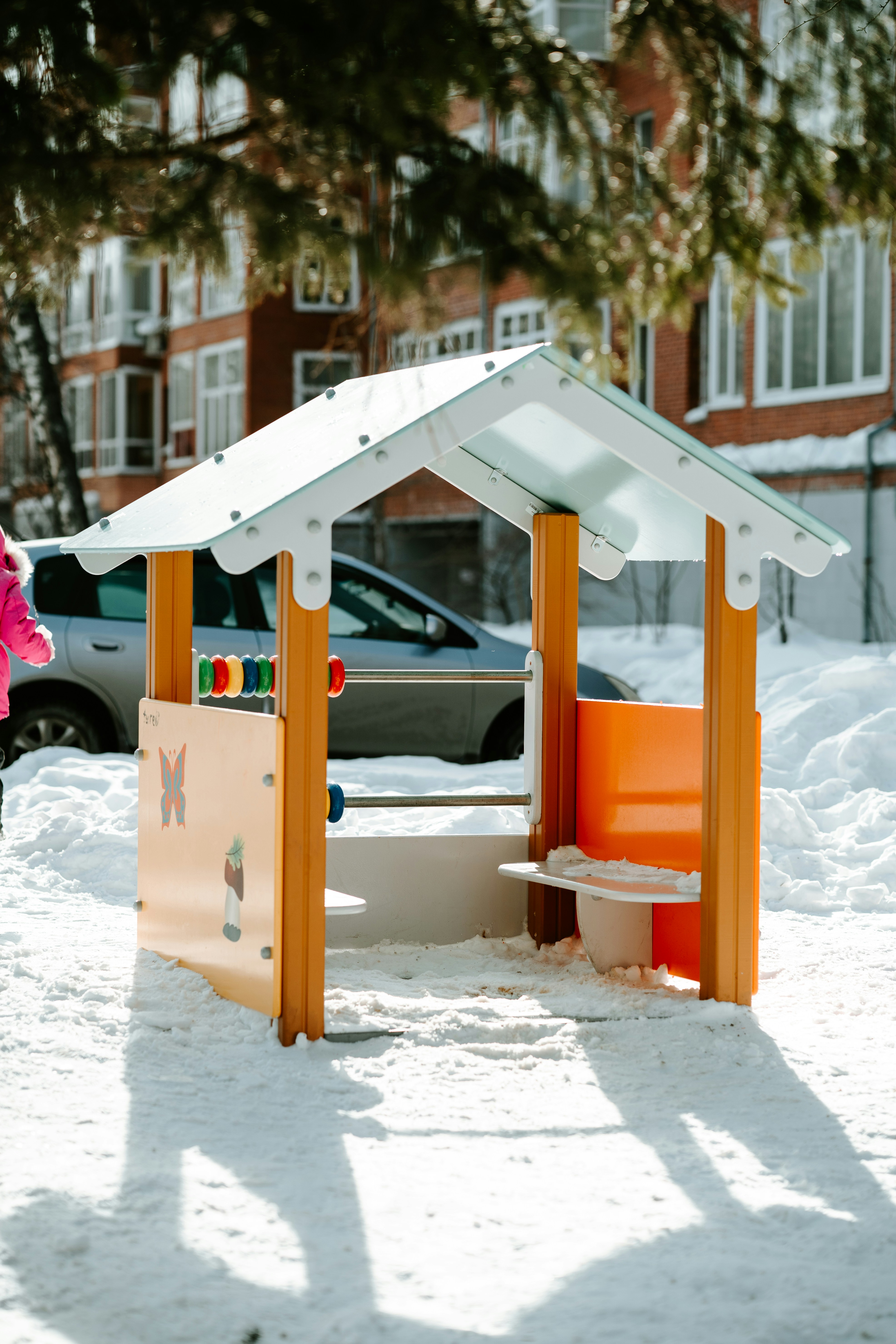 Winter Light on a Tiny Playground Pavilion: Orange Posts Framing Snow