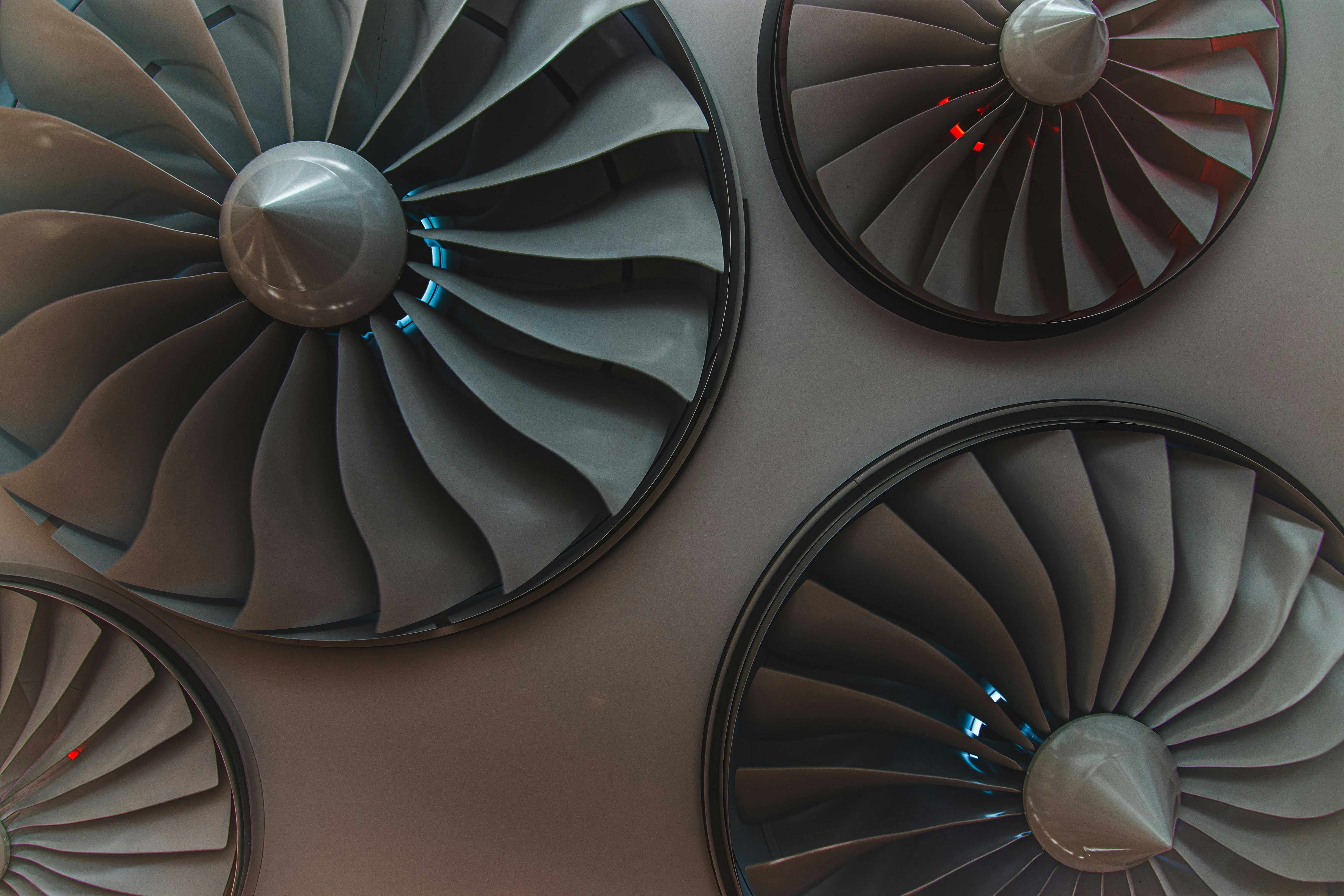 A group of three jet engines mounted to the side of a wall photo – Free ...