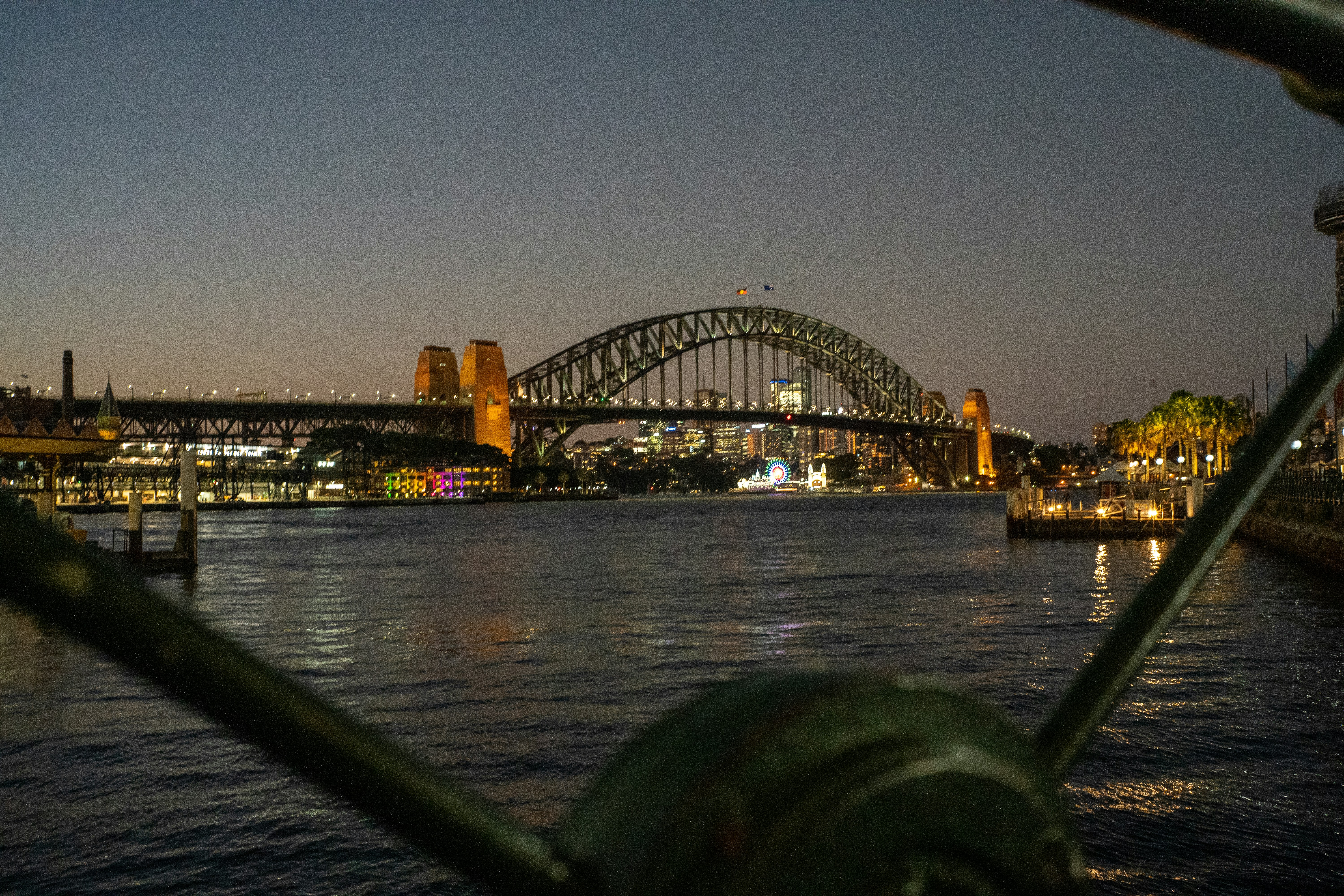 Blue Hour Over a Steel Arch: City Lights Mirror on Night Waters
